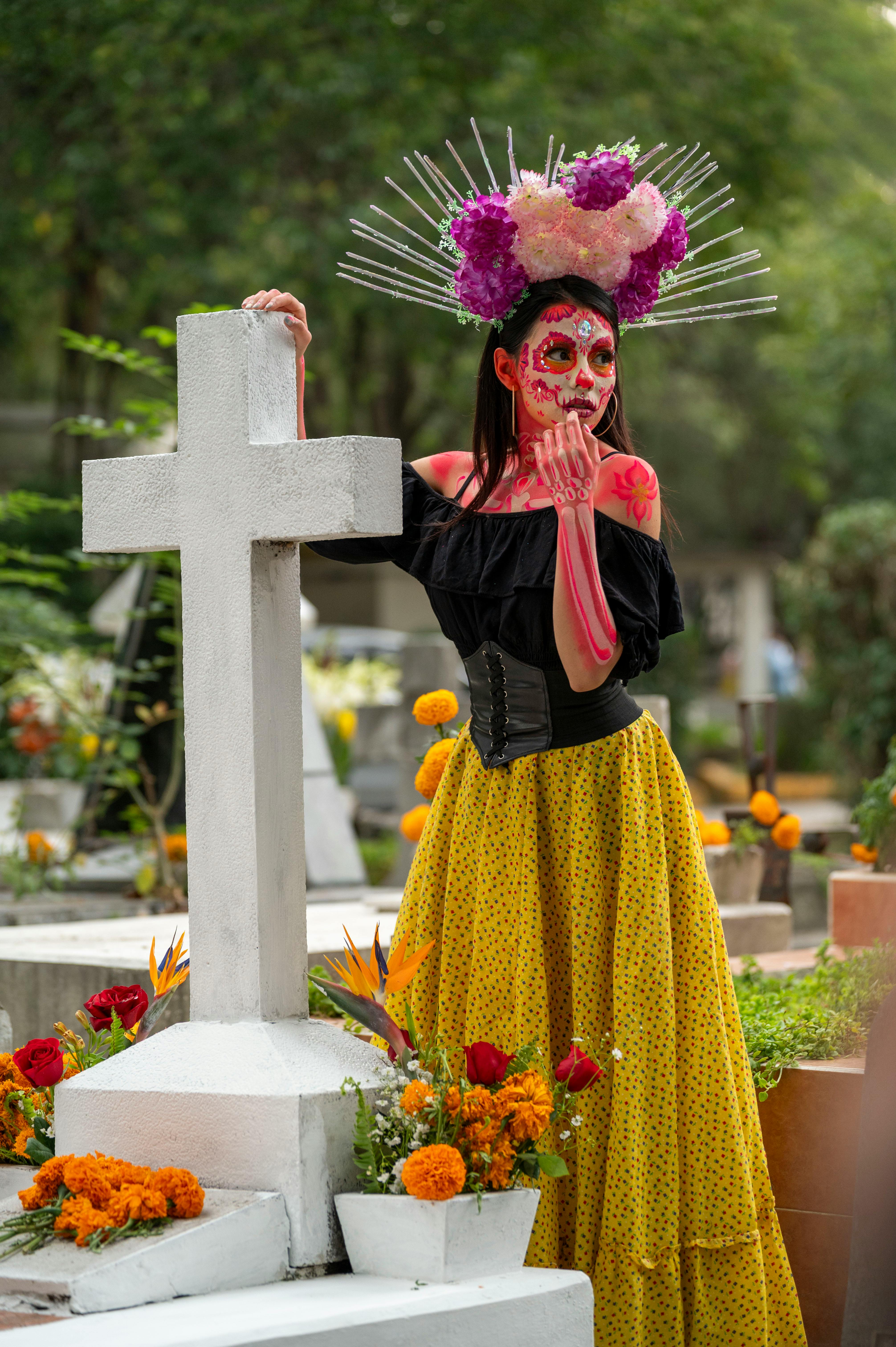 Catrina Standing near Cross on Grave at Cemetery · Free Stock Photo