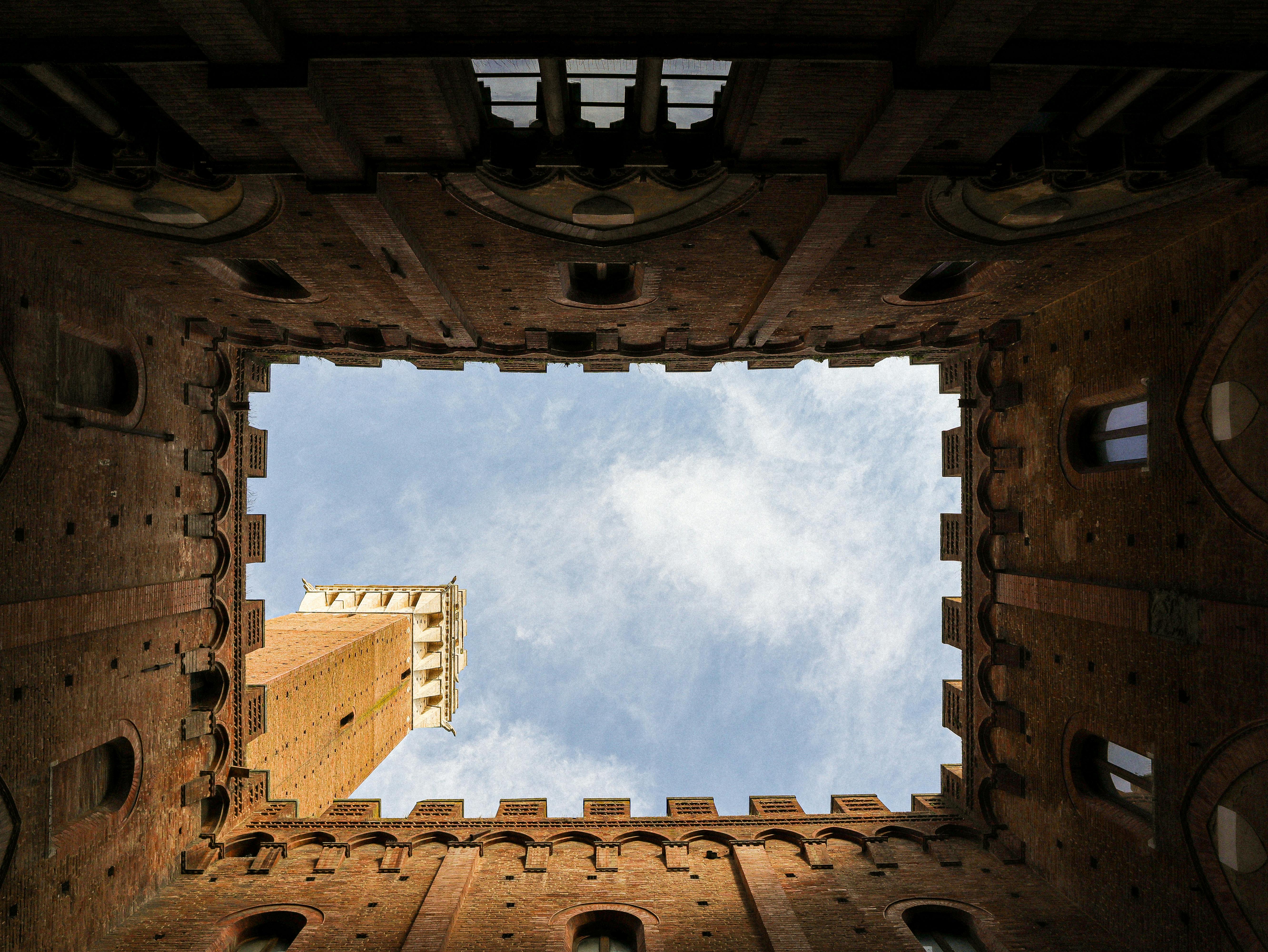 A view of a tower looking up at the sky · Free Stock Photo