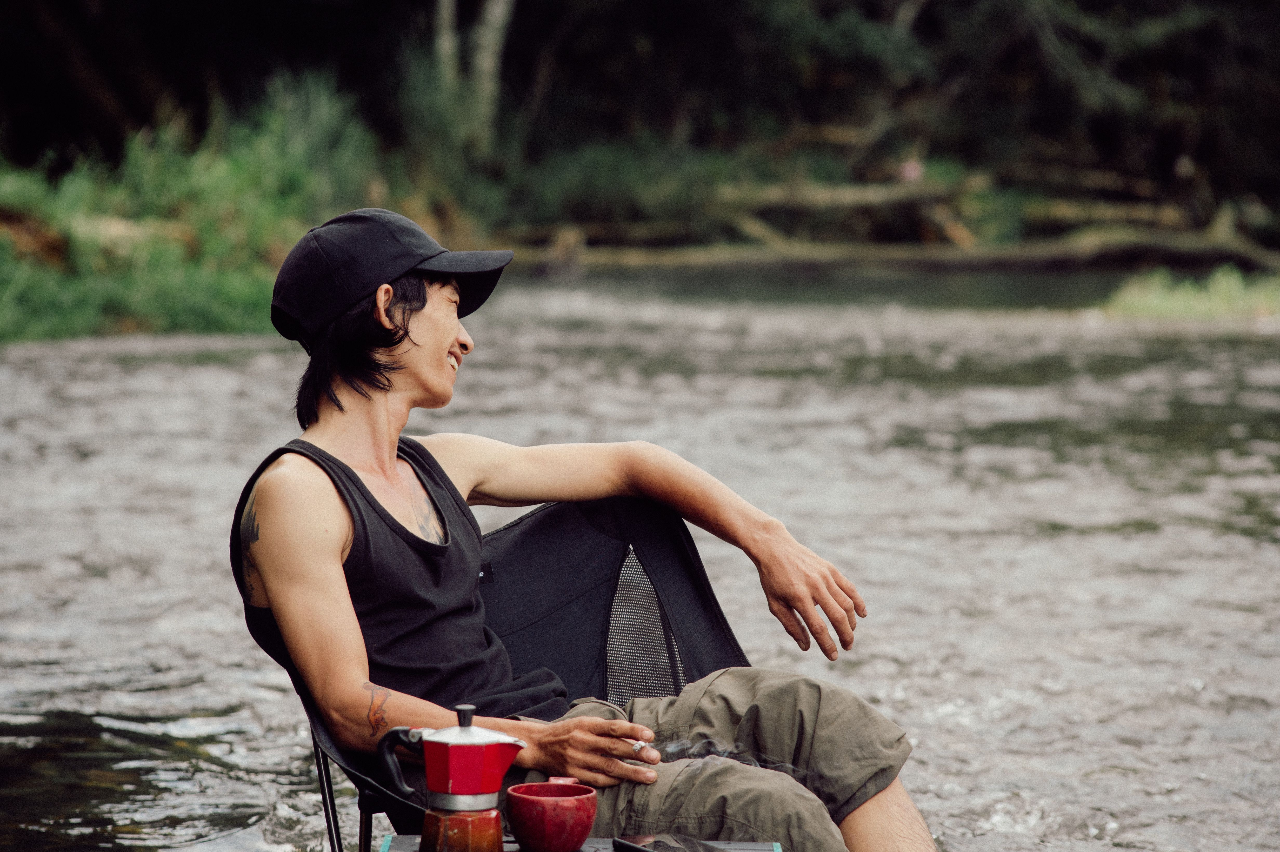 Woman Sitting by the Stream in a Forest · Free Stock Photo
