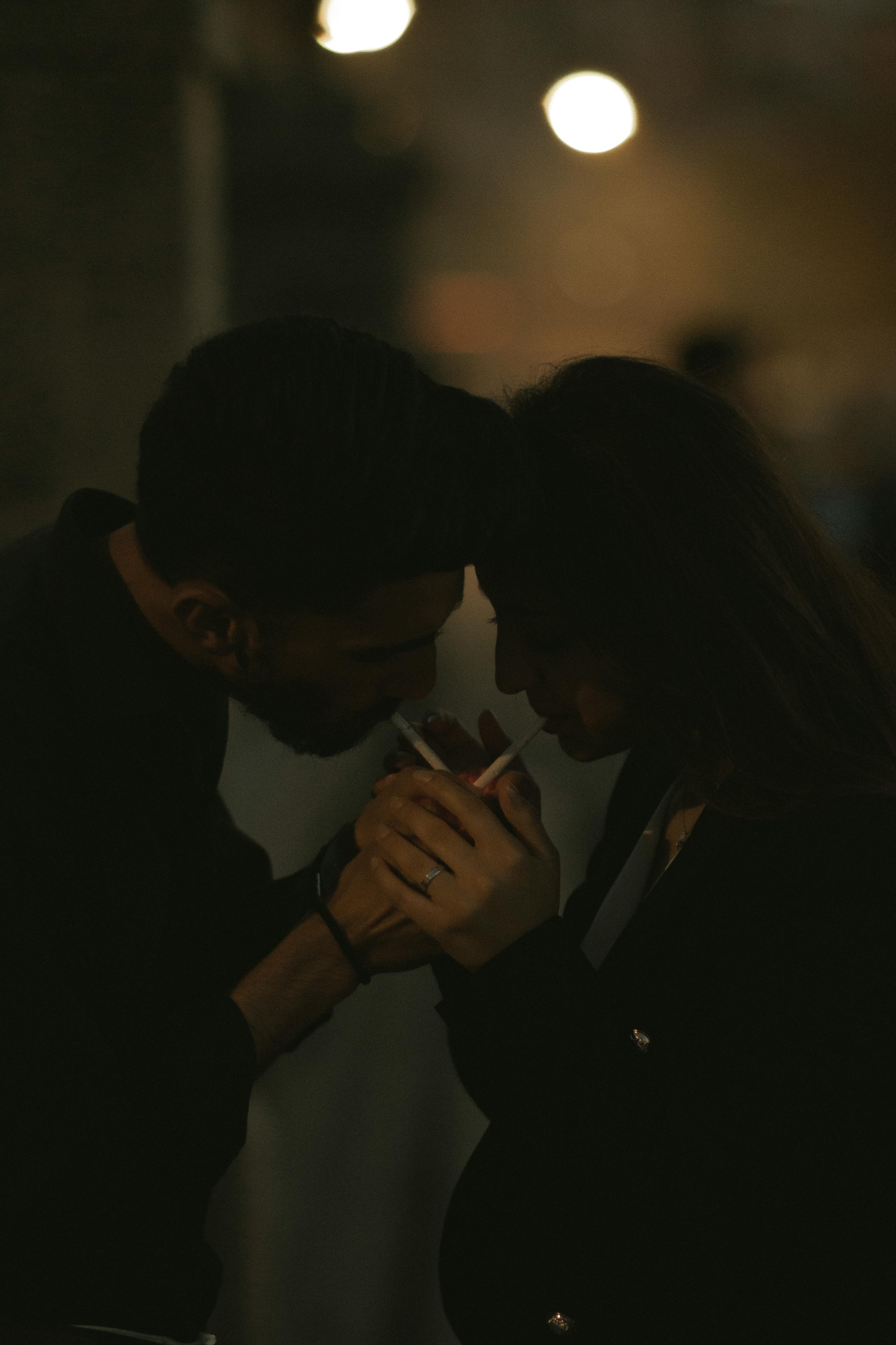 Two People Smoking Cigarettes Together · Free Stock Photo