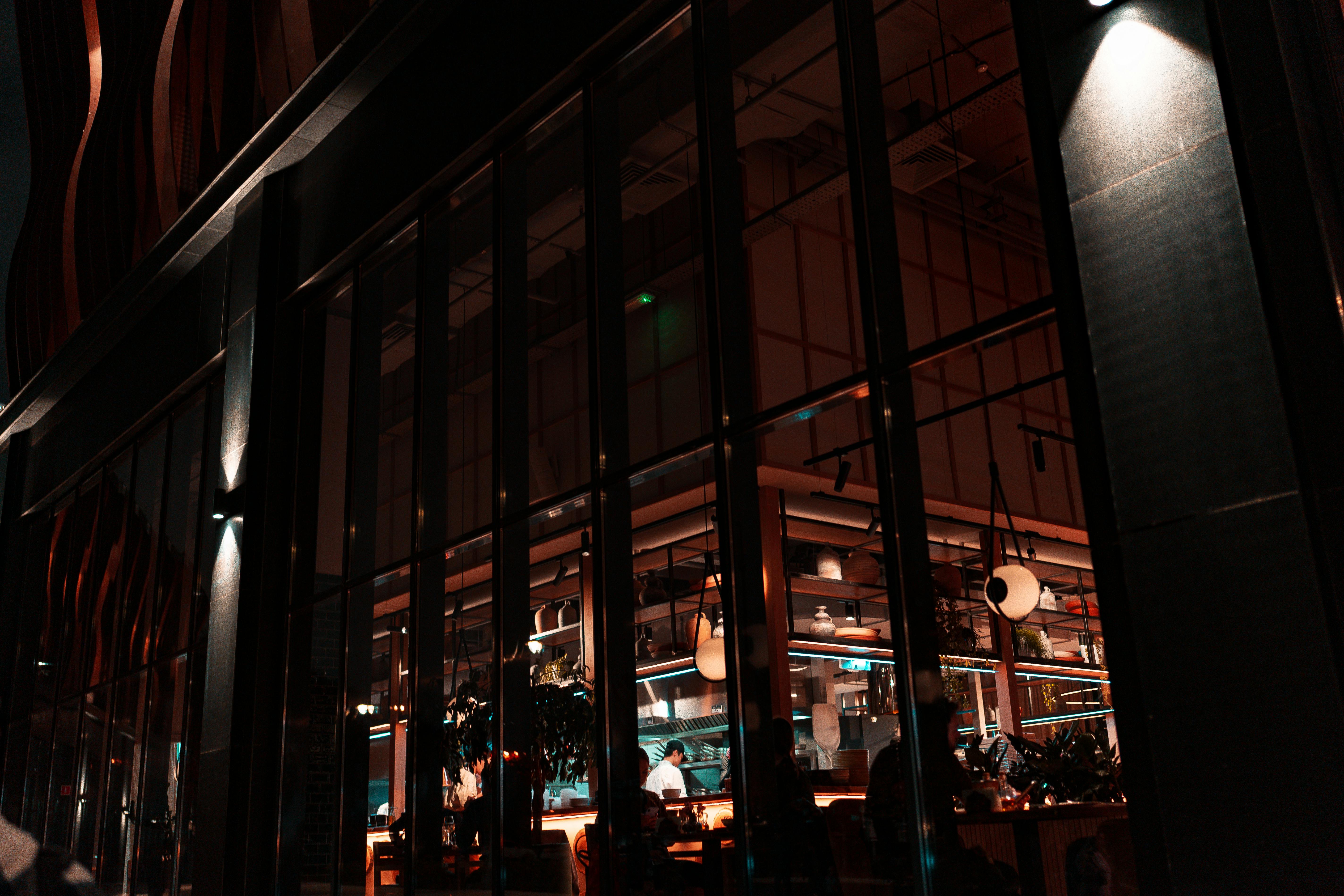 Street Food Stall next to Restaurant at Night · Free Stock Photo