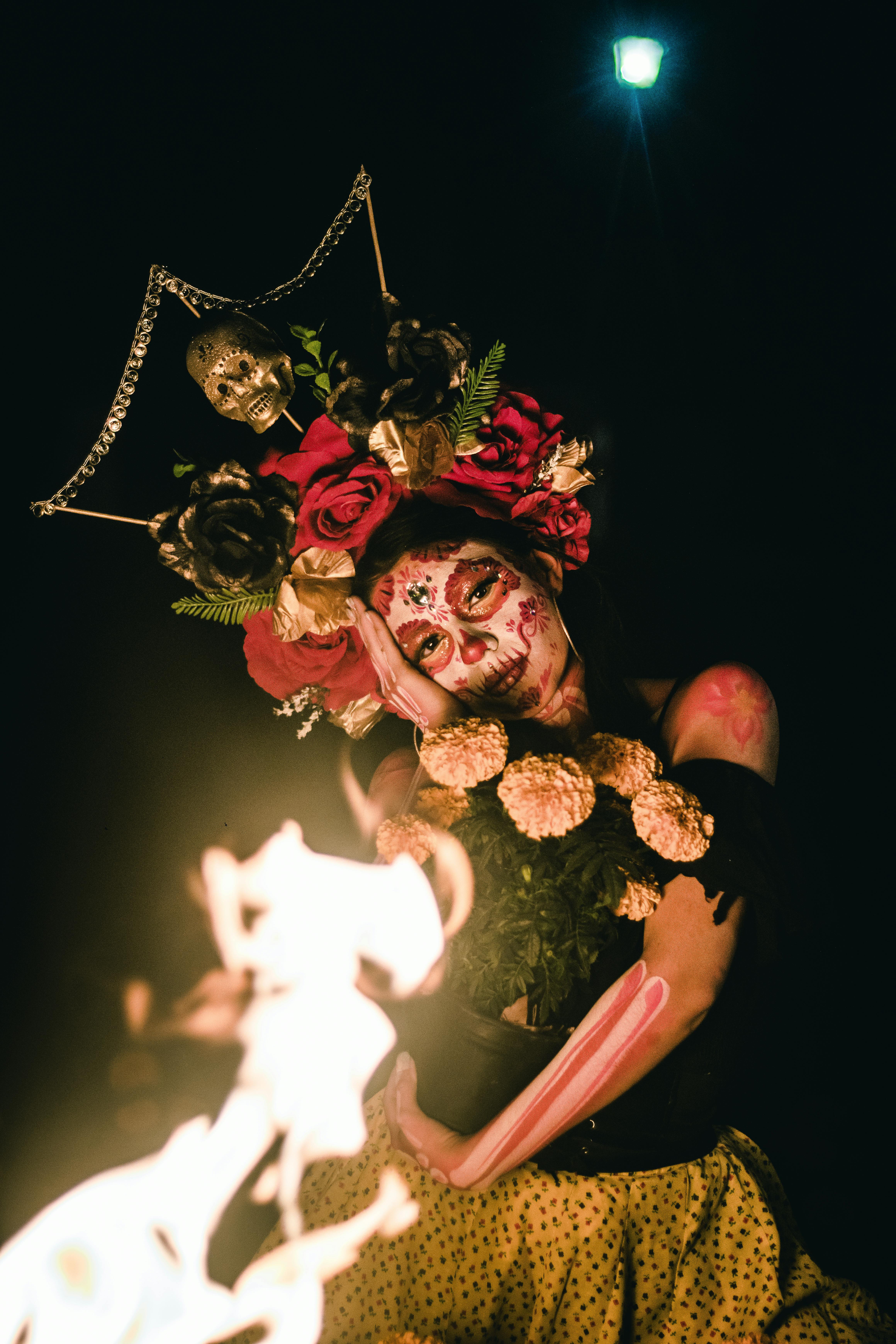 Catrina Standing behind Fire at Night · Free Stock Photo