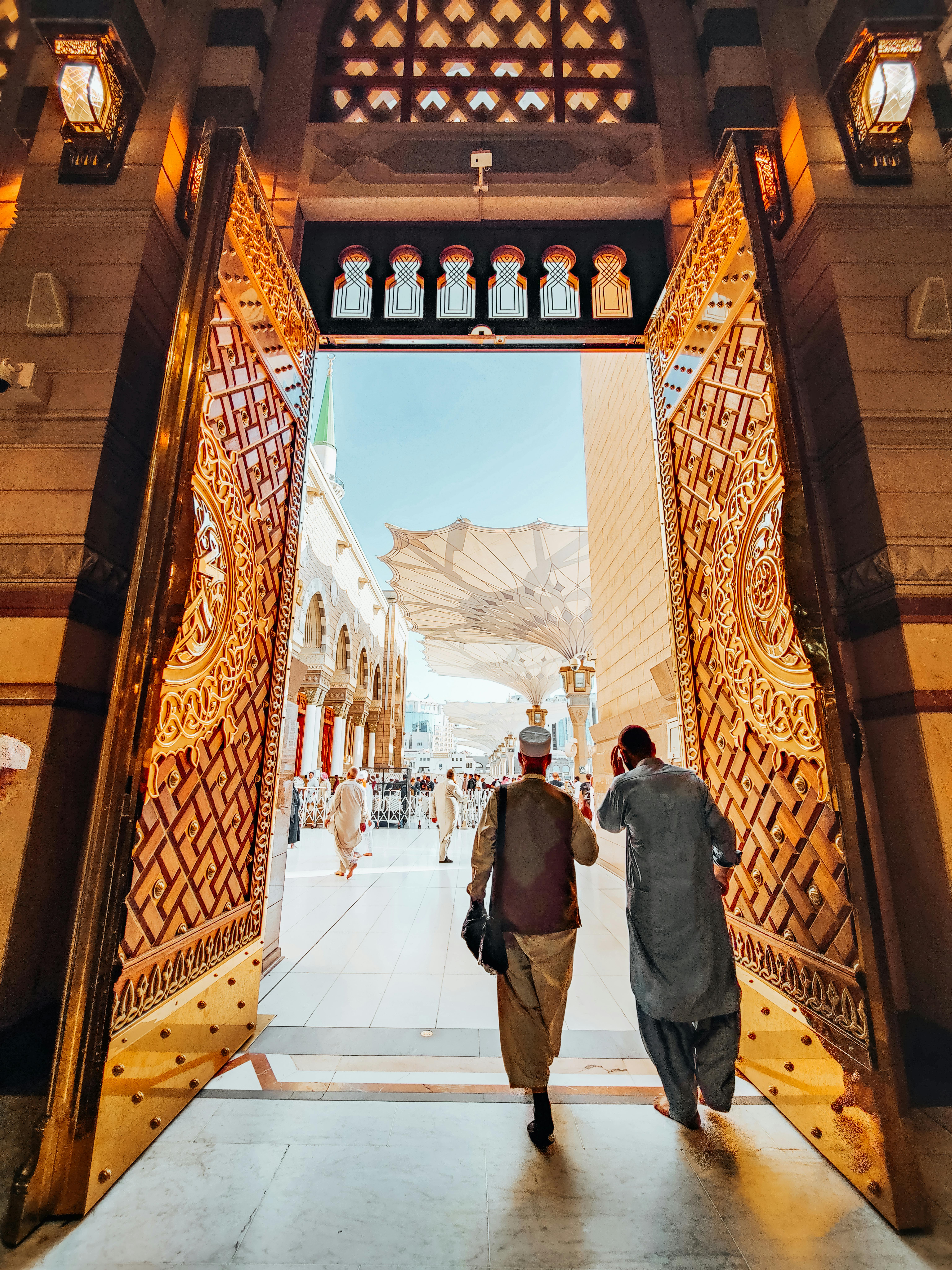 Men in Traditional Clothing Walking through Othman Bin Affan Gate ...