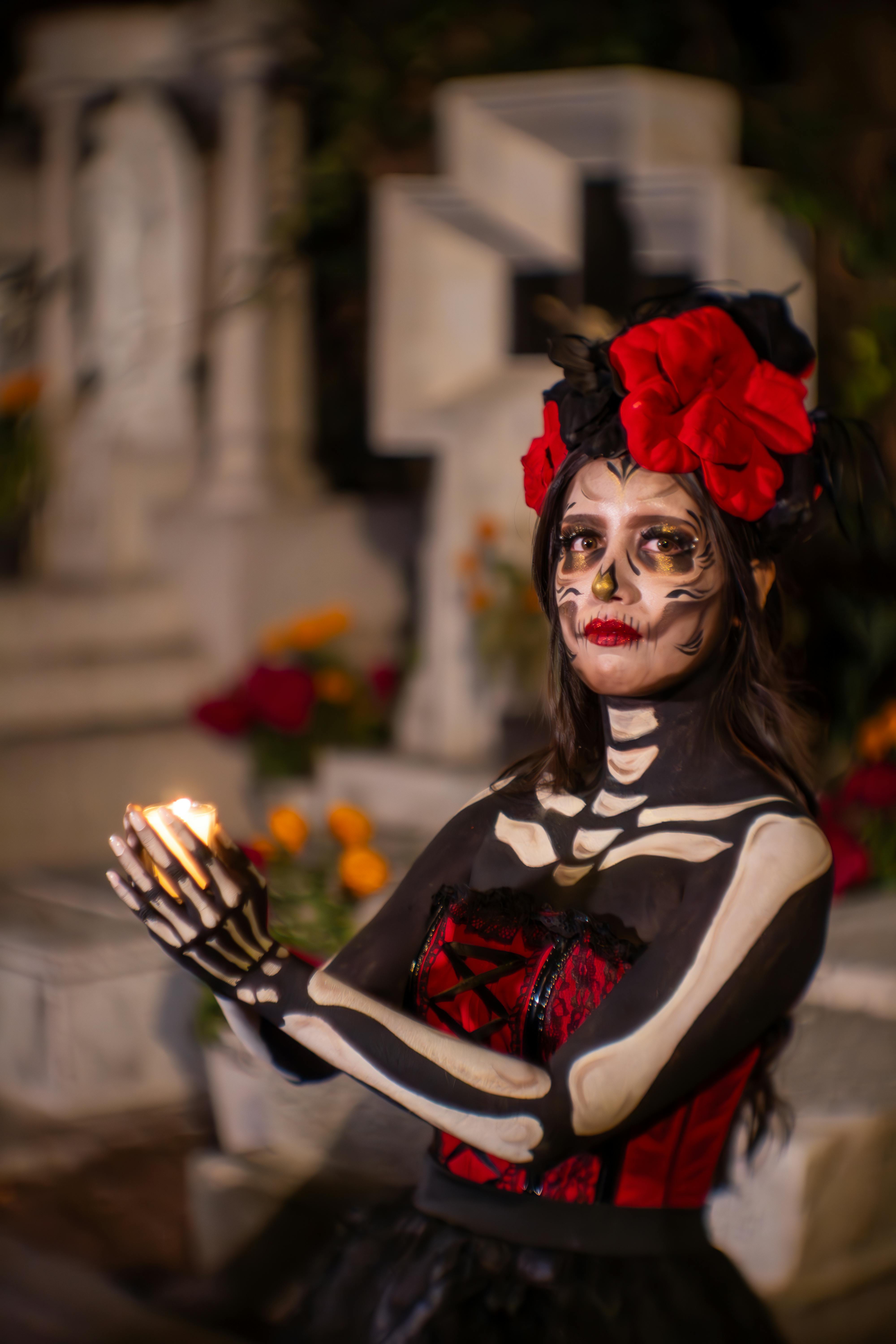 Woman Dressed as a Catrina Holding a Candle · Free Stock Photo