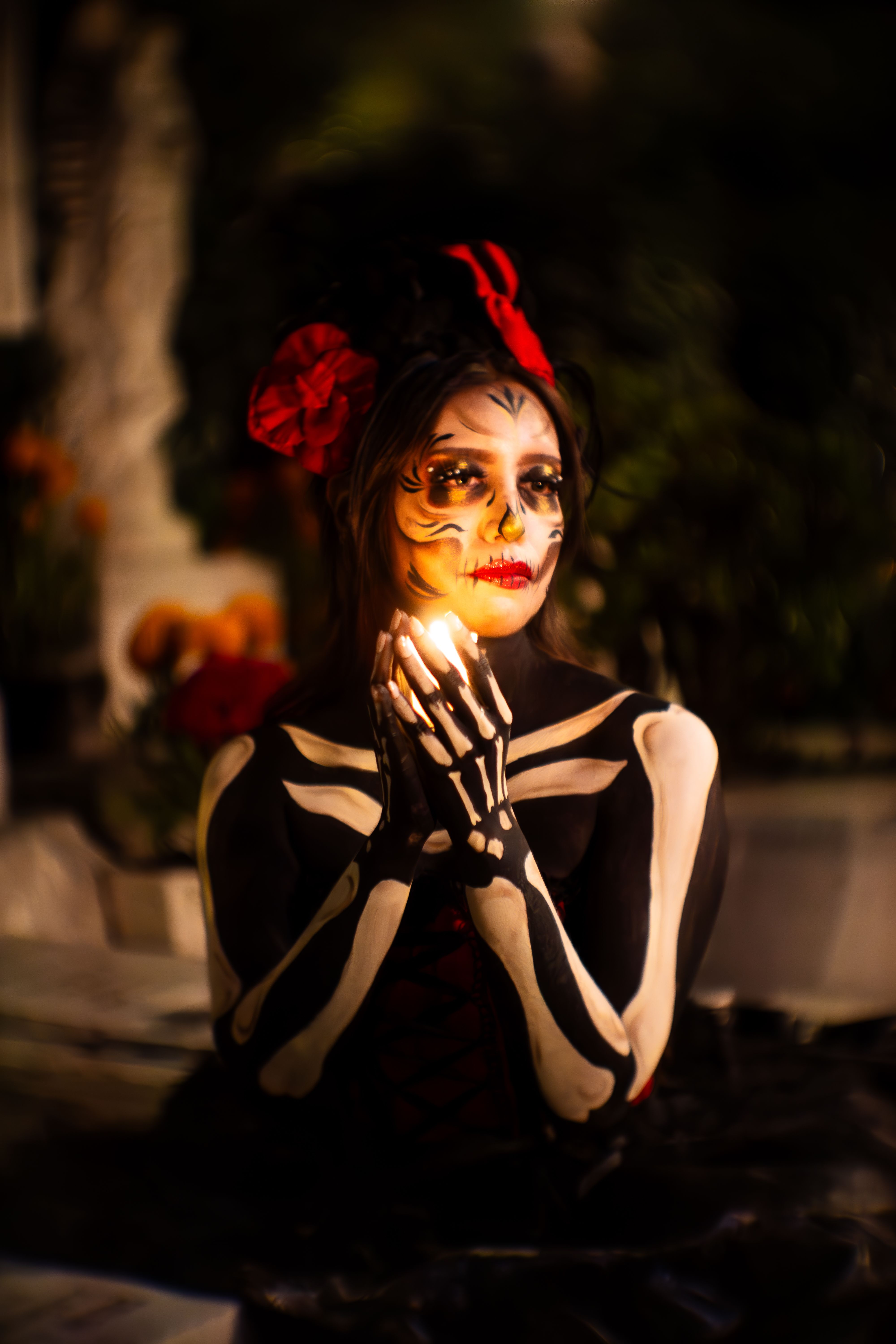 Woman in Skeleton Costume Holding Light between Hands · Free Stock Photo