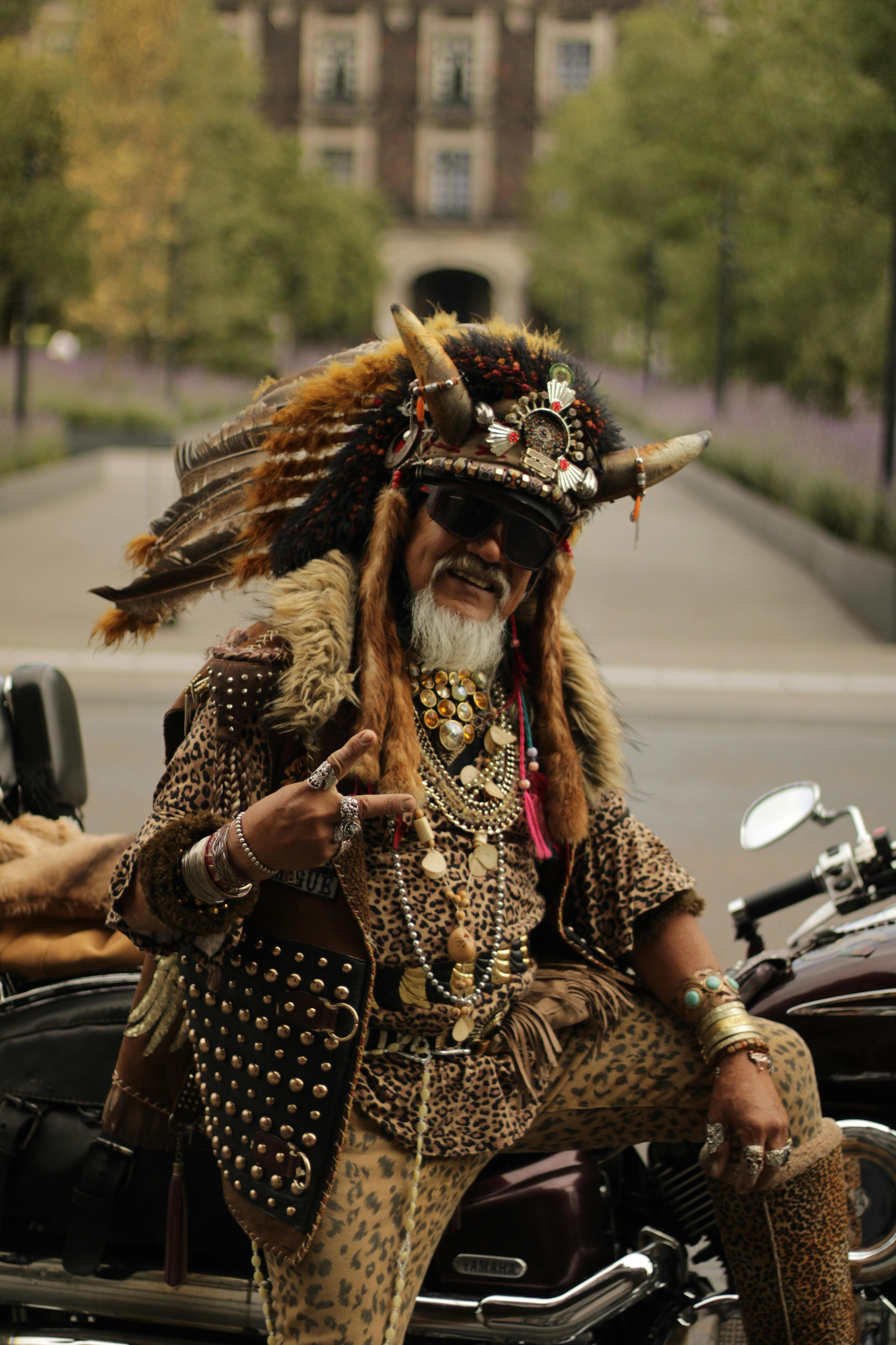 A Man with a Gray Beard Wearing a Costume Sitting on a Motorcycle ...