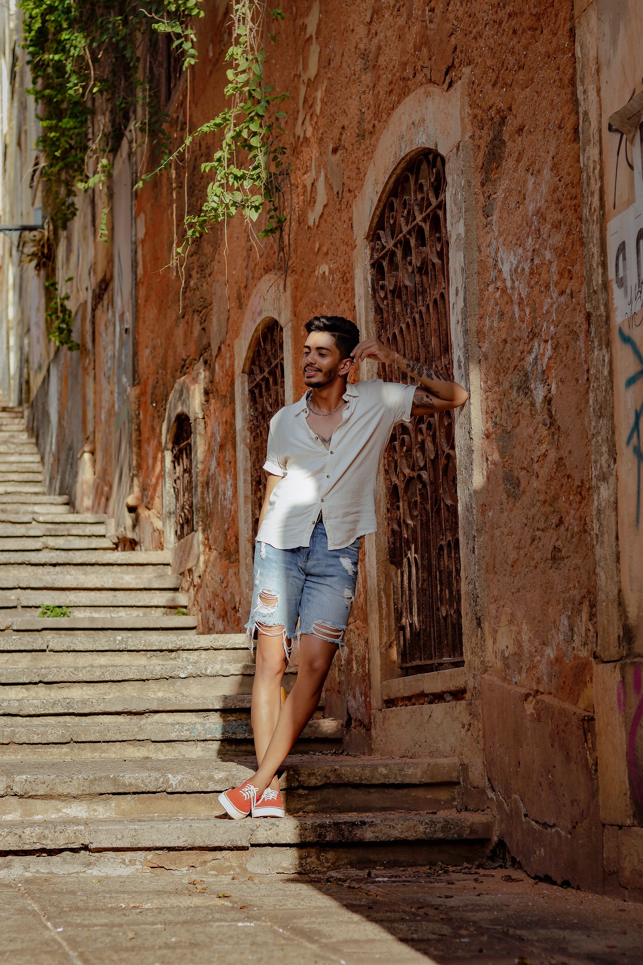 Man Standing on Steps and Leaning against an Old Building · Free Stock ...