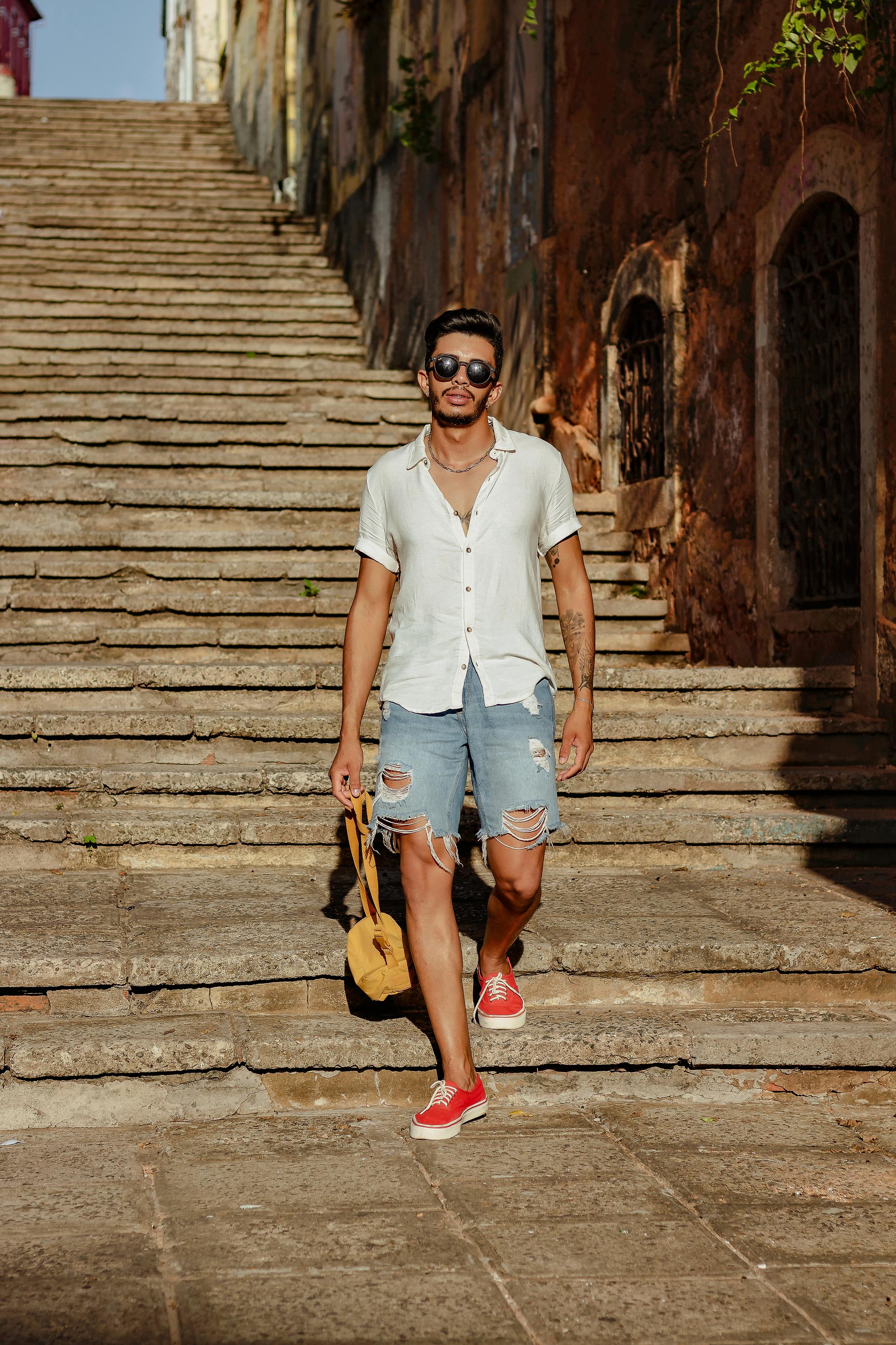 Man Walking on Steps between Old Buildings · Free Stock Photo
