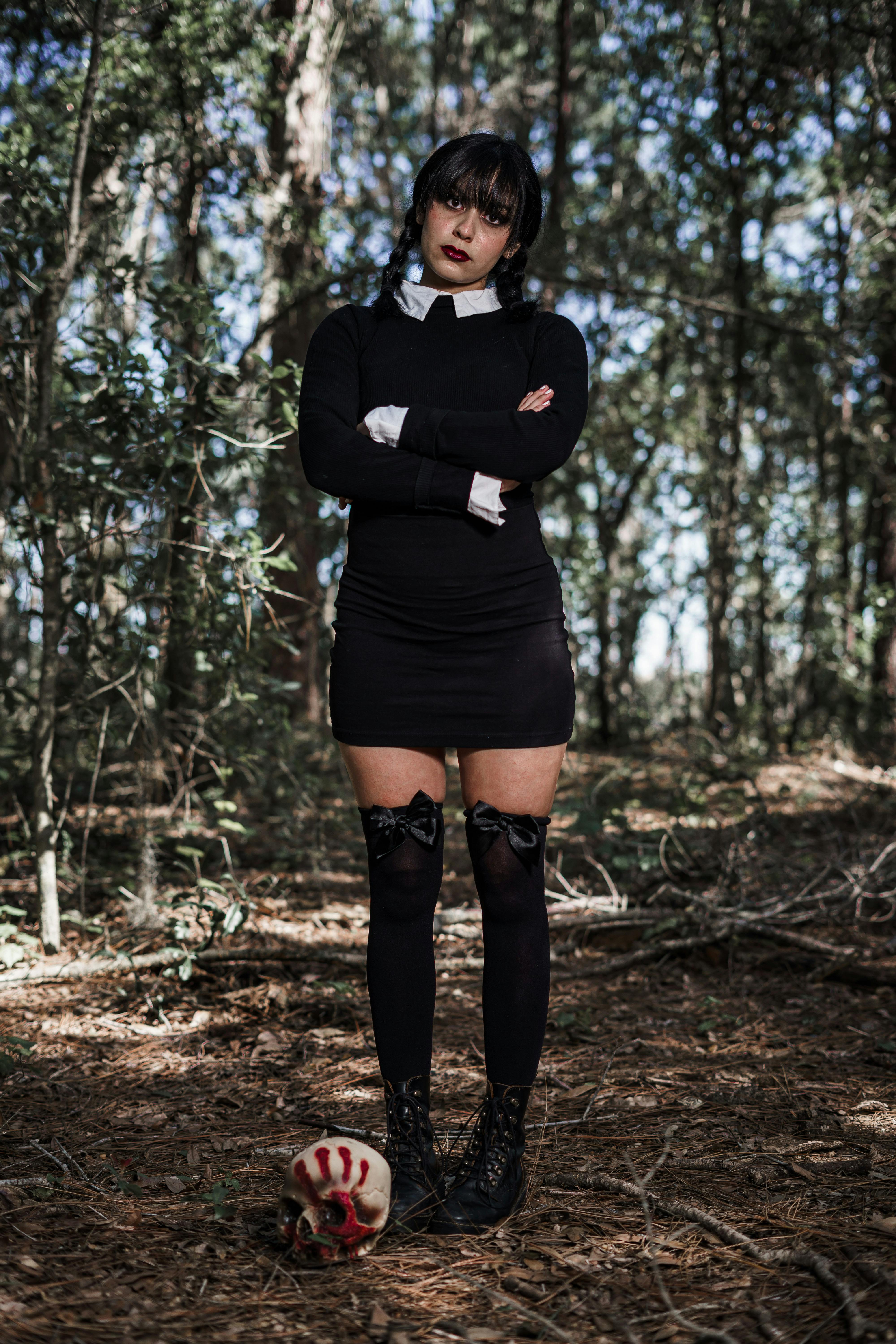 Girl in the Wednesday Addams Costume Writing on a Typewriter · Free ...