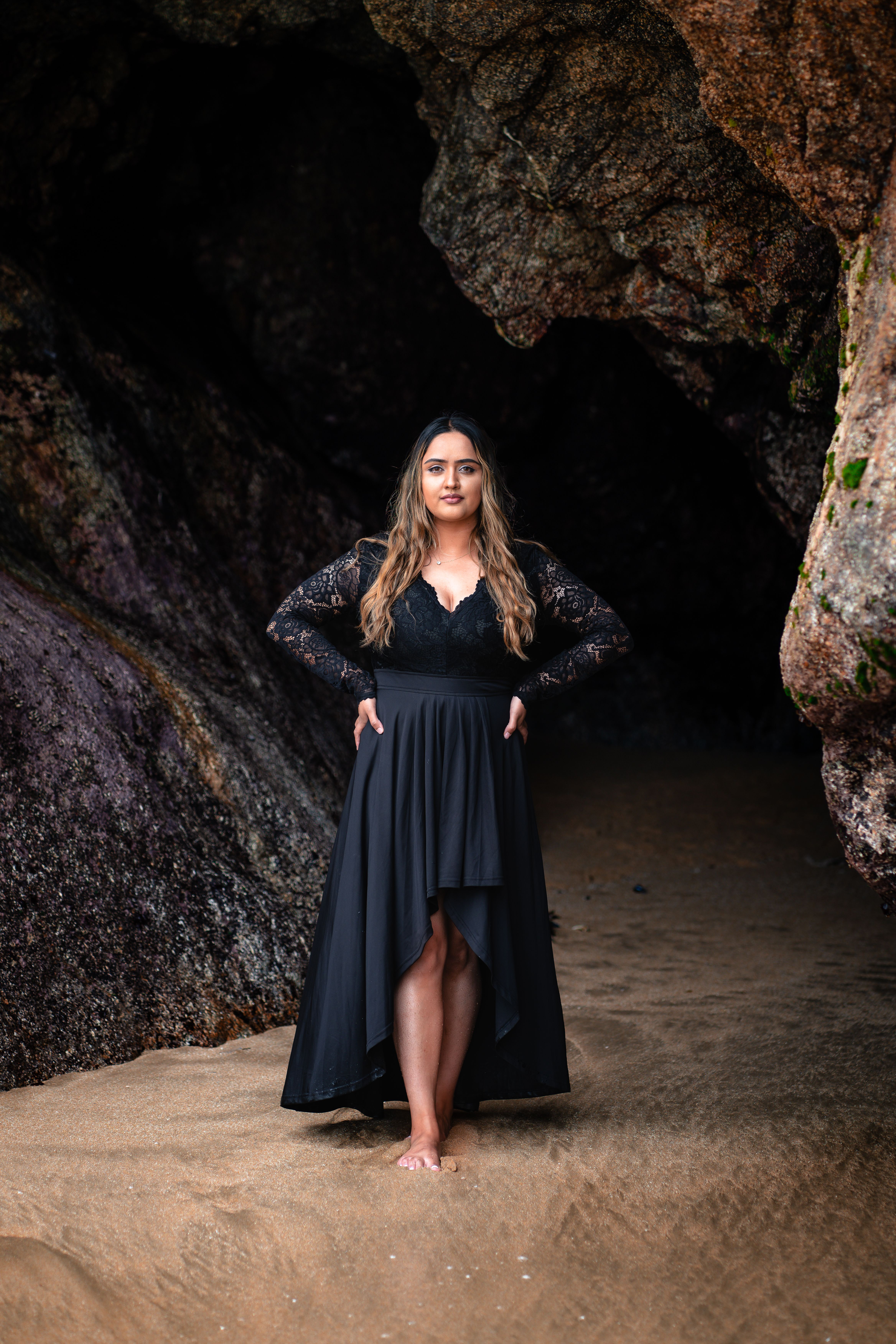 Elegant Woman Posing in Dark Cave Setting · Free Stock Photo