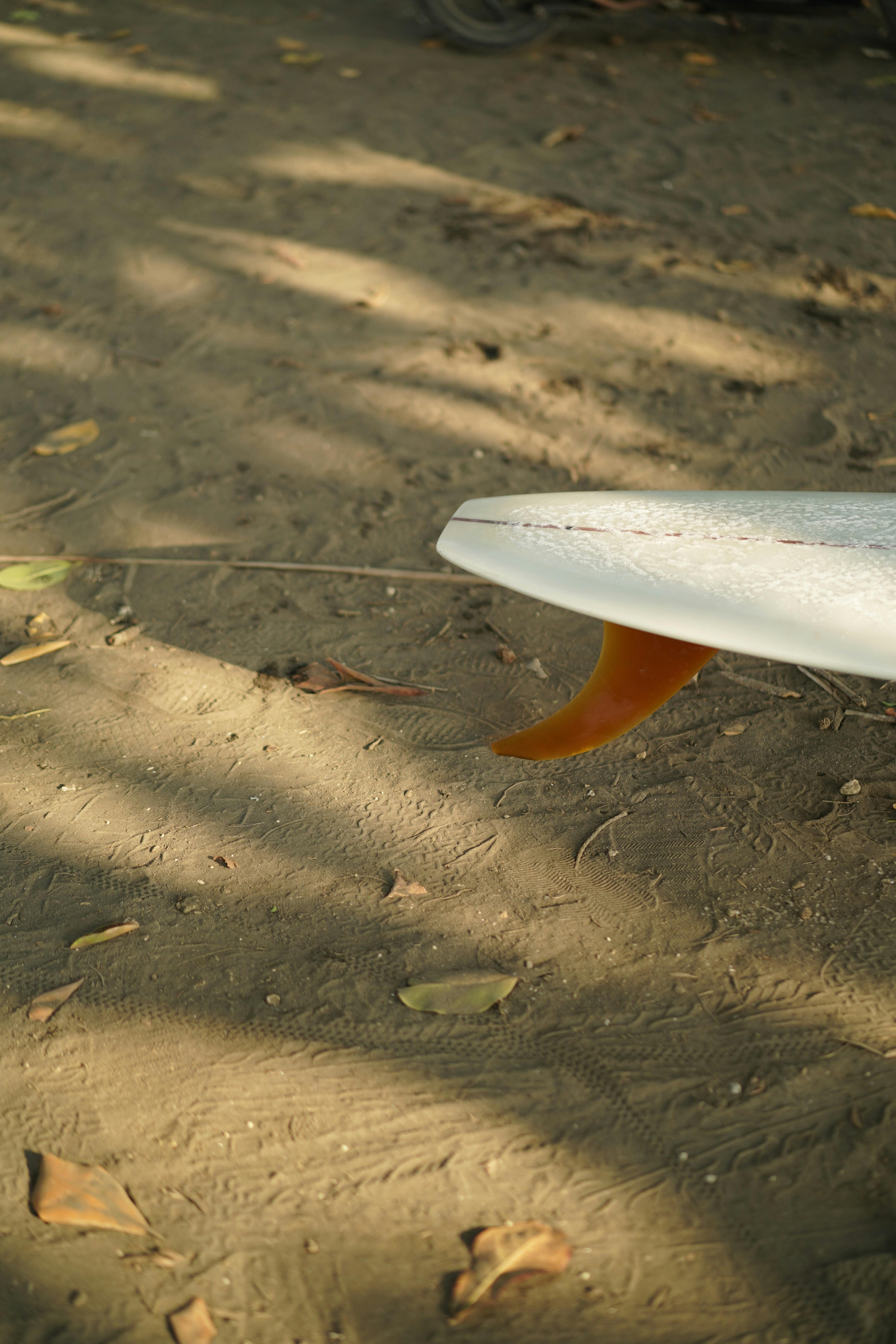 High-Angle Shot of a Surfboard on the Shore · Free Stock Photo