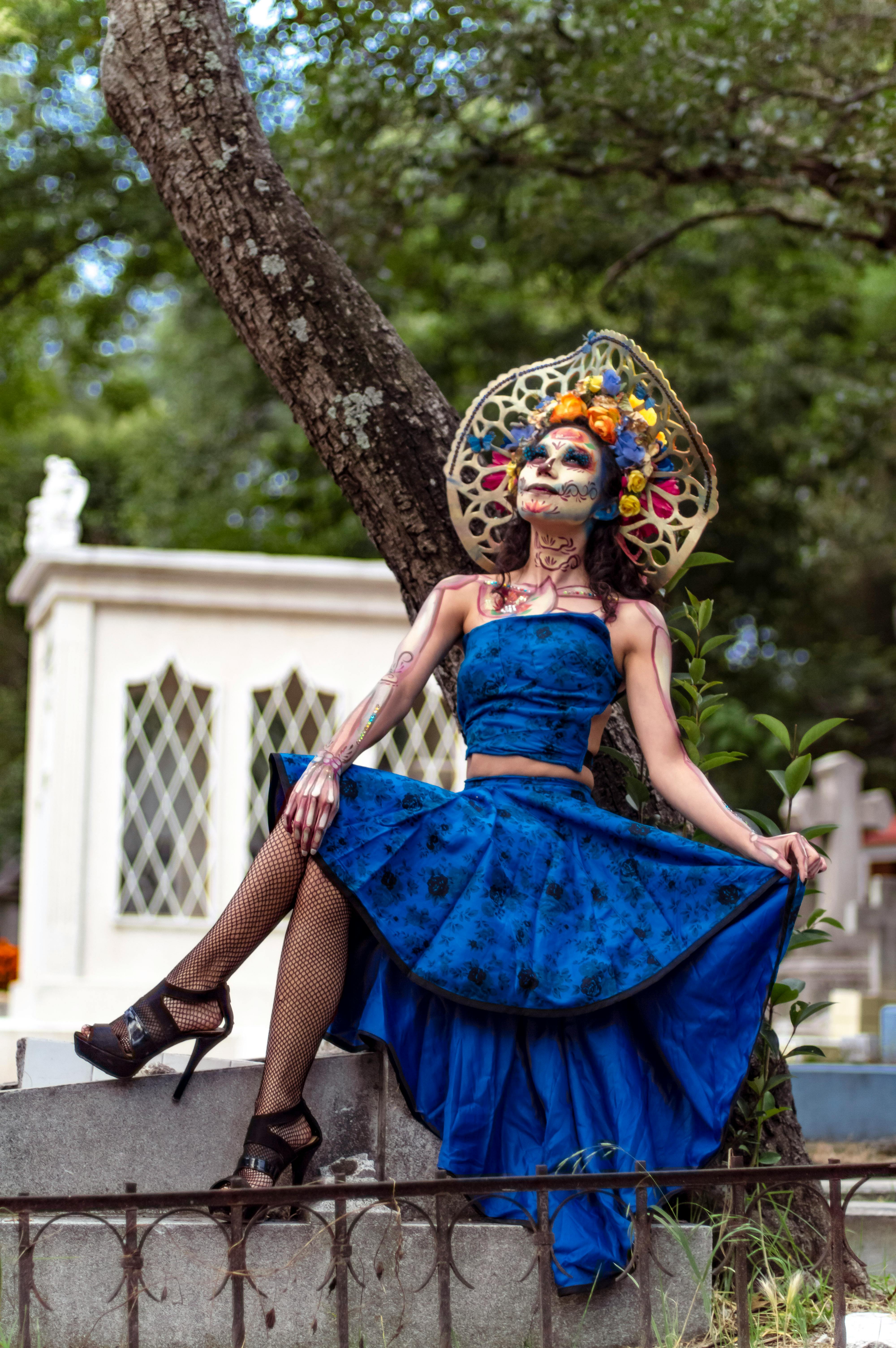Catrina in Blue Dress Sitting in Cemetery · Free Stock Photo