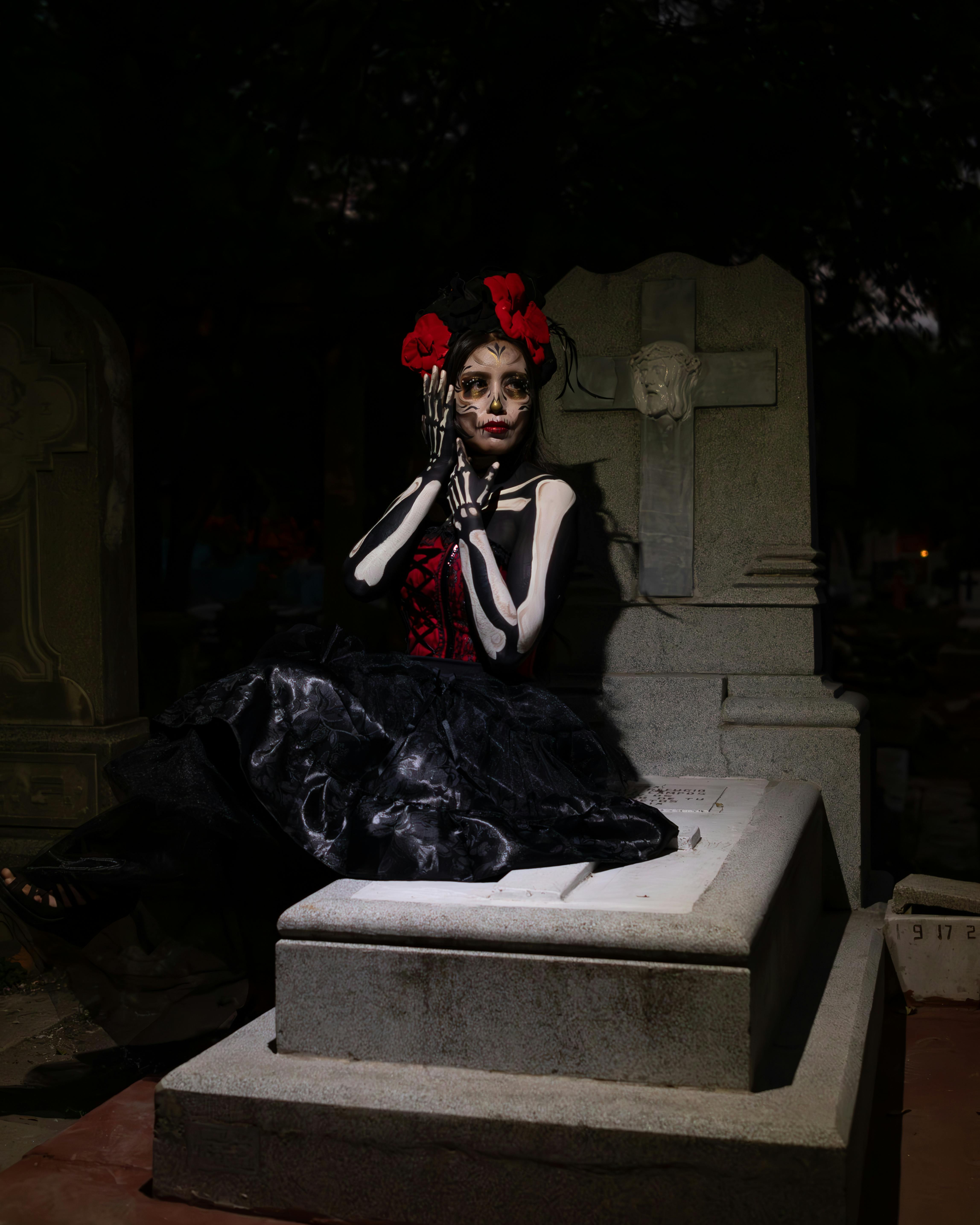 Woman in Catrina Costume Posing on Grave · Free Stock Photo