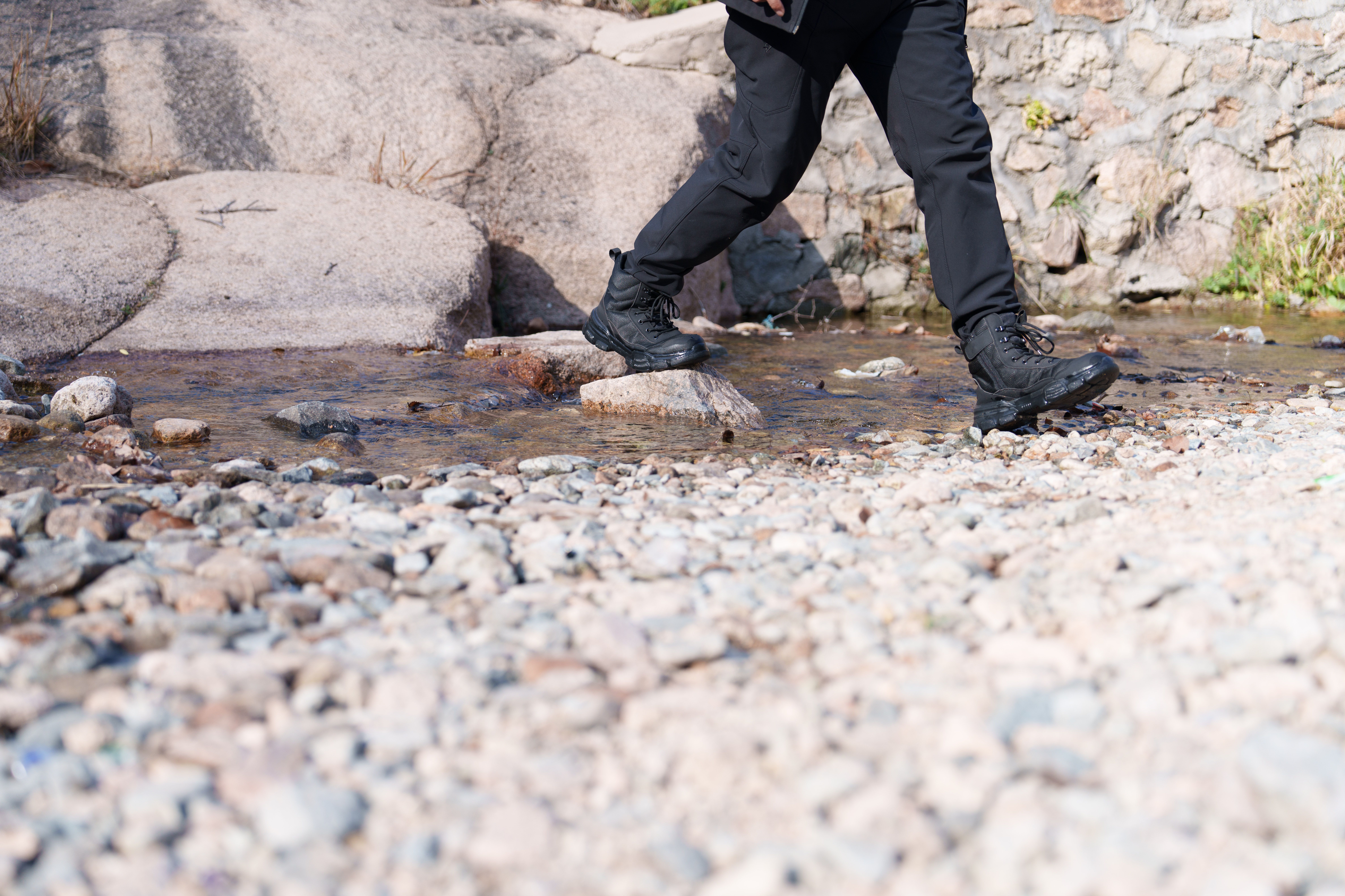 Legs of Person Crossing Shallow Stream · Free Stock Photo