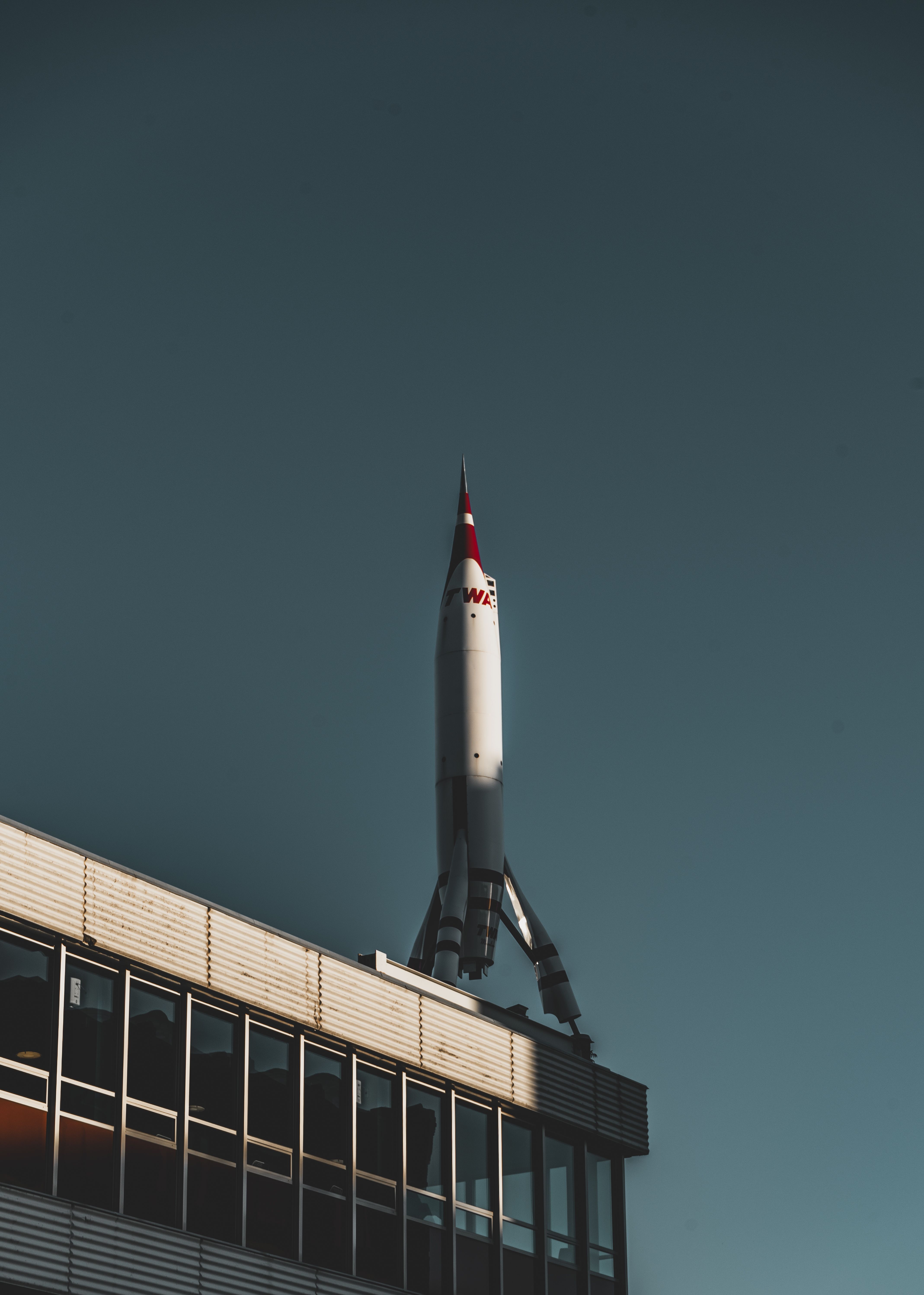 Rocket on Building Roof · Free Stock Photo