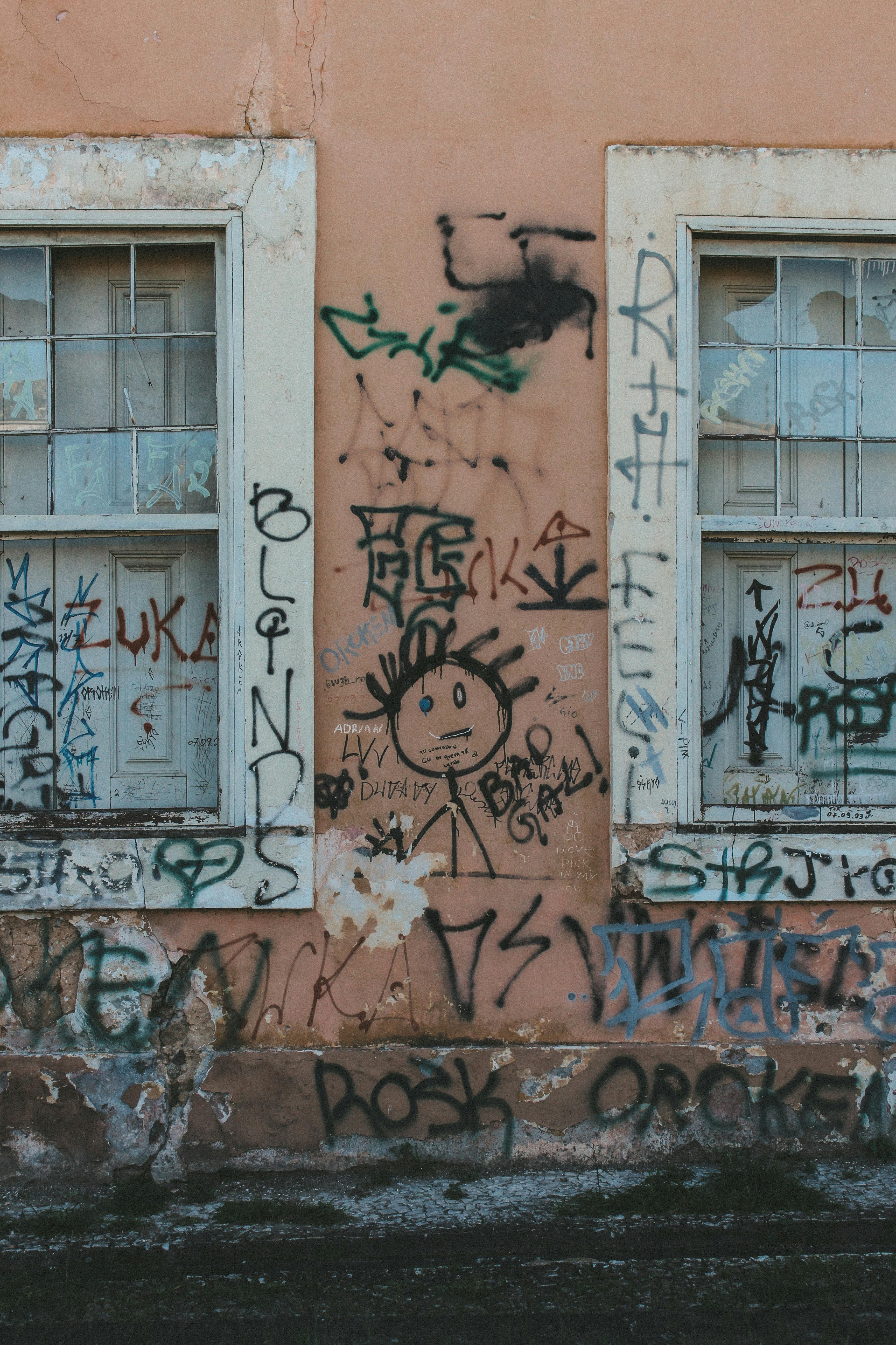 A wall with graffiti on it and a window · Free Stock Photo