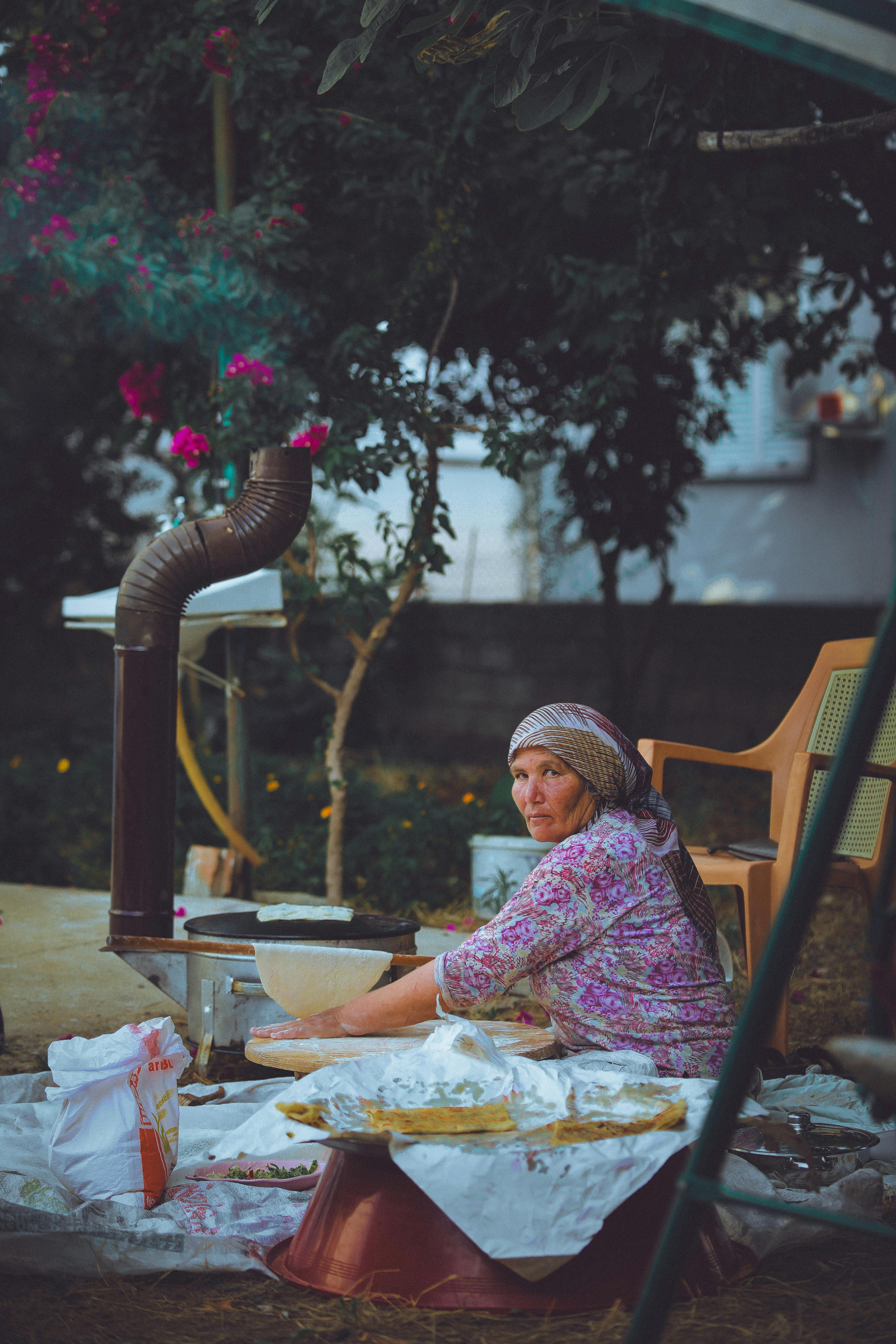 Elderly Woman Cooking Outside · Free Stock Photo