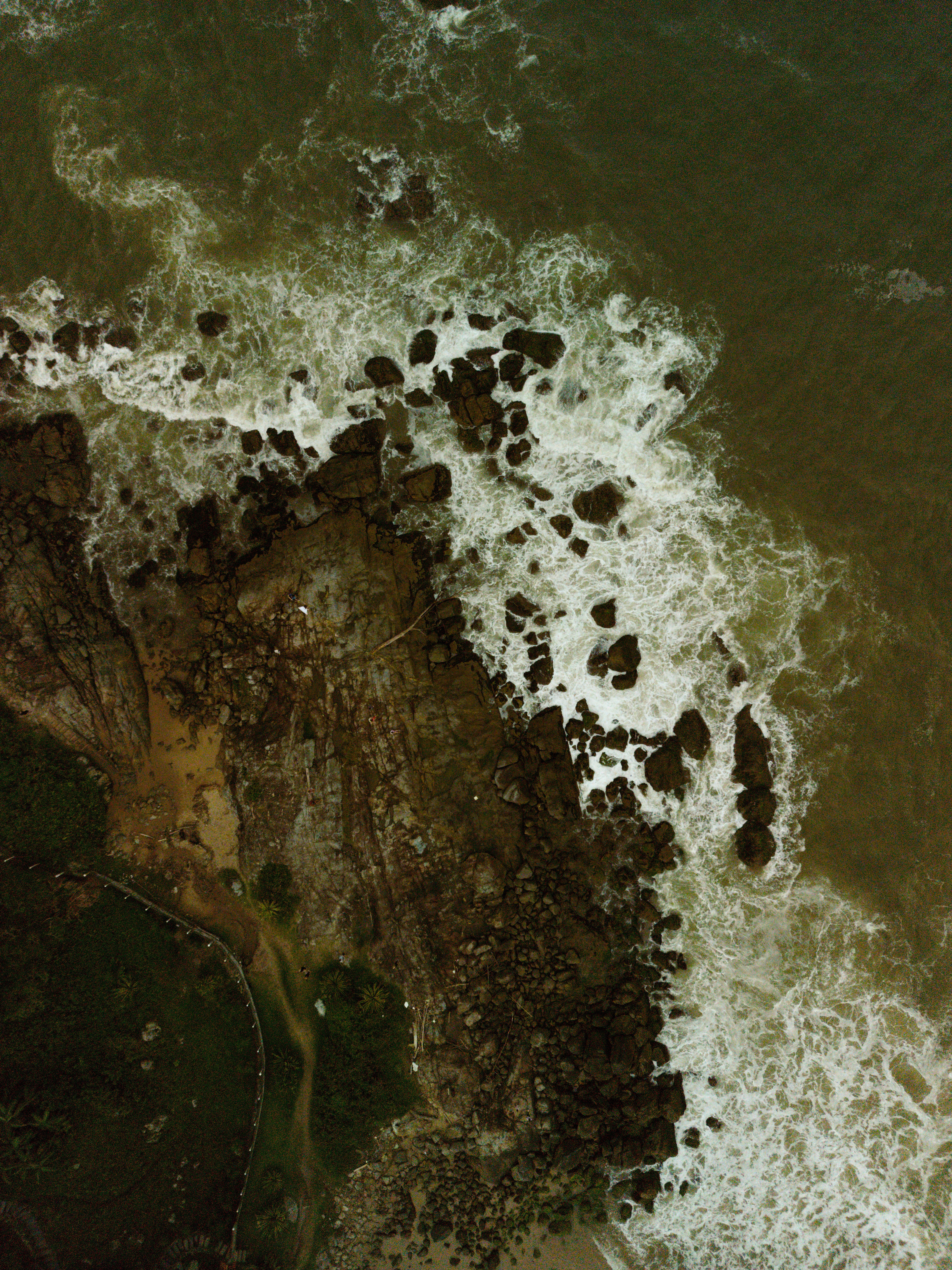 Top View of Waves Crashing on a Rocky Shore · Free Stock Photo