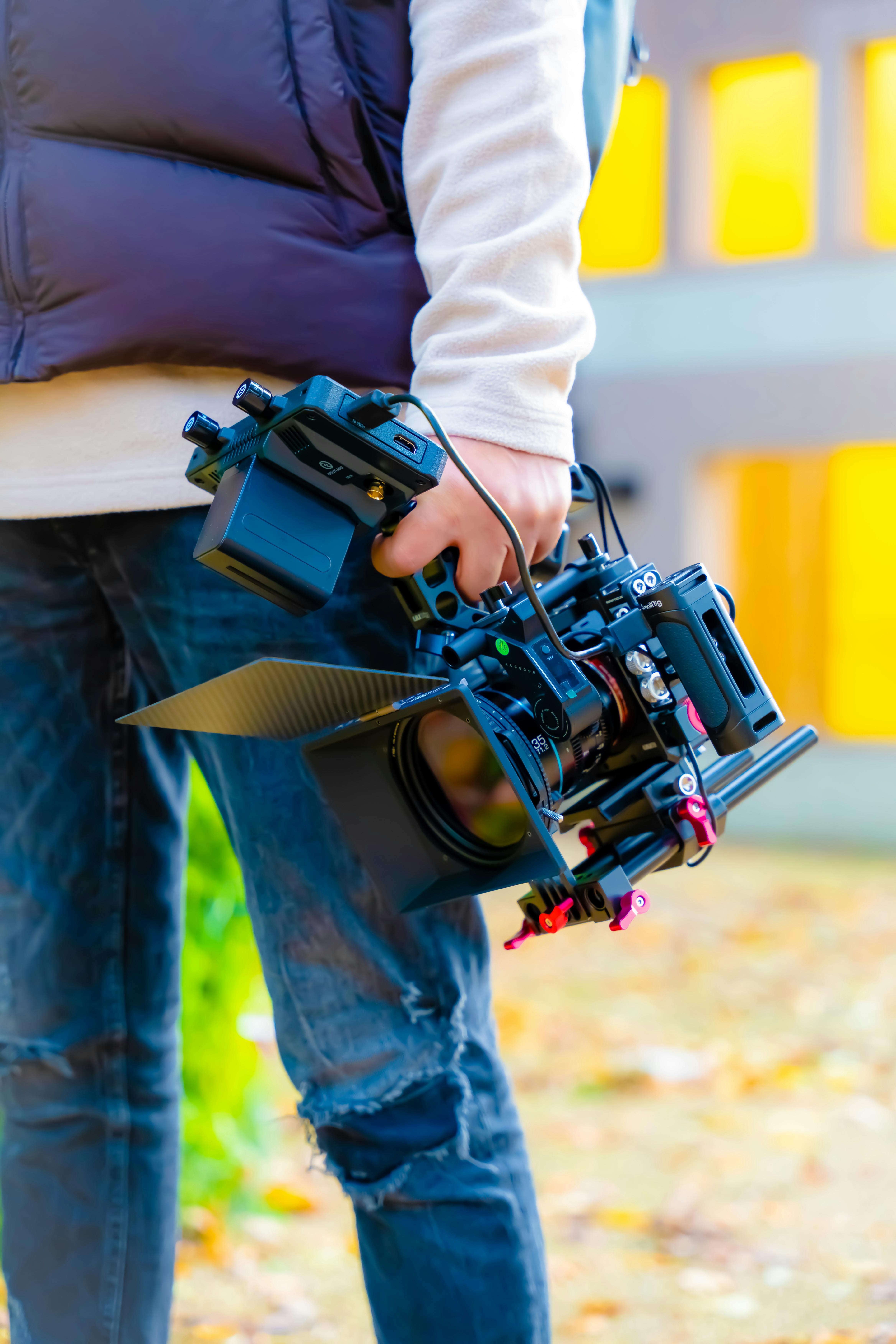 Professional Black Camera in Hand · Free Stock Photo