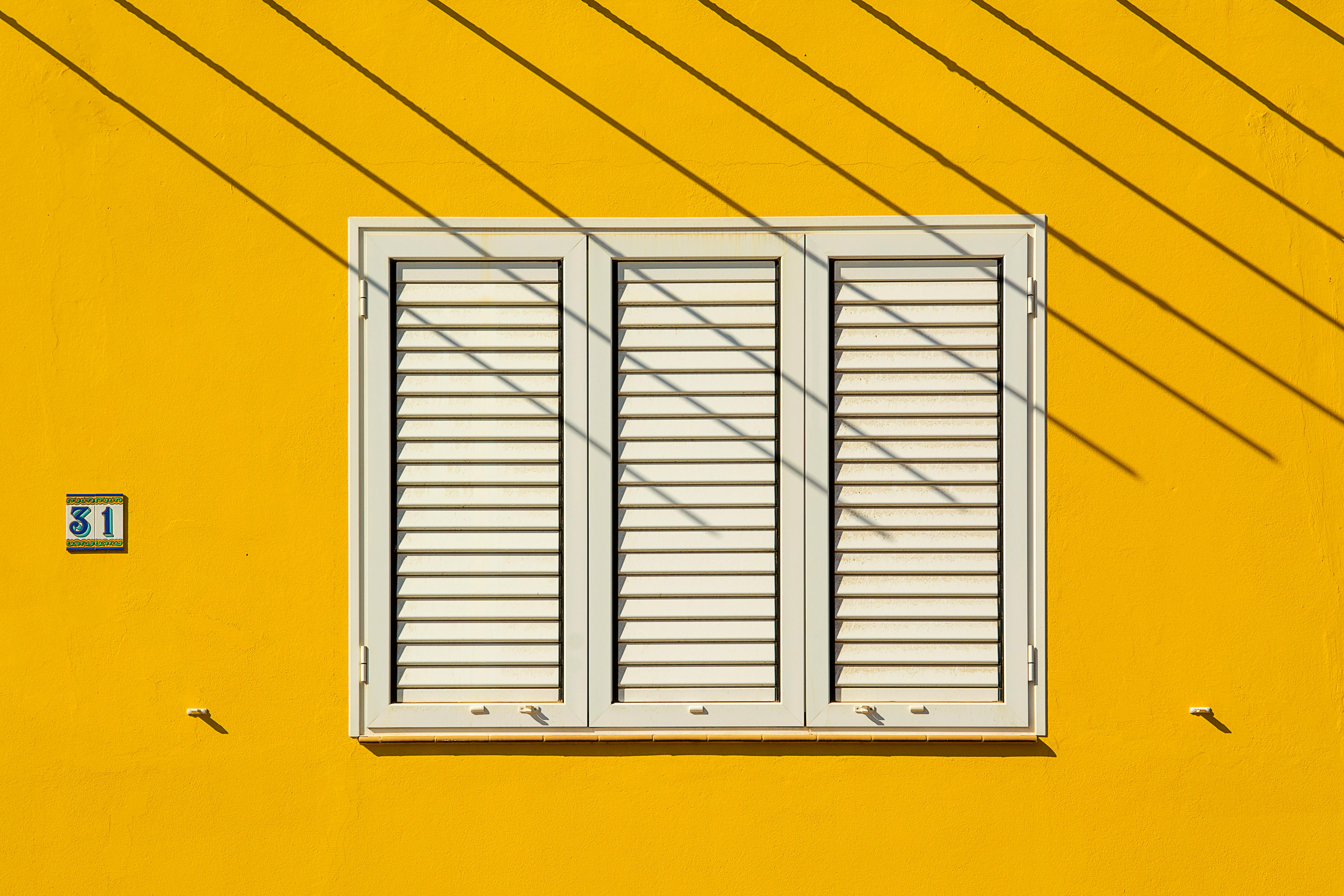 Window with Shutters in Yellow Wall · Free Stock Photo