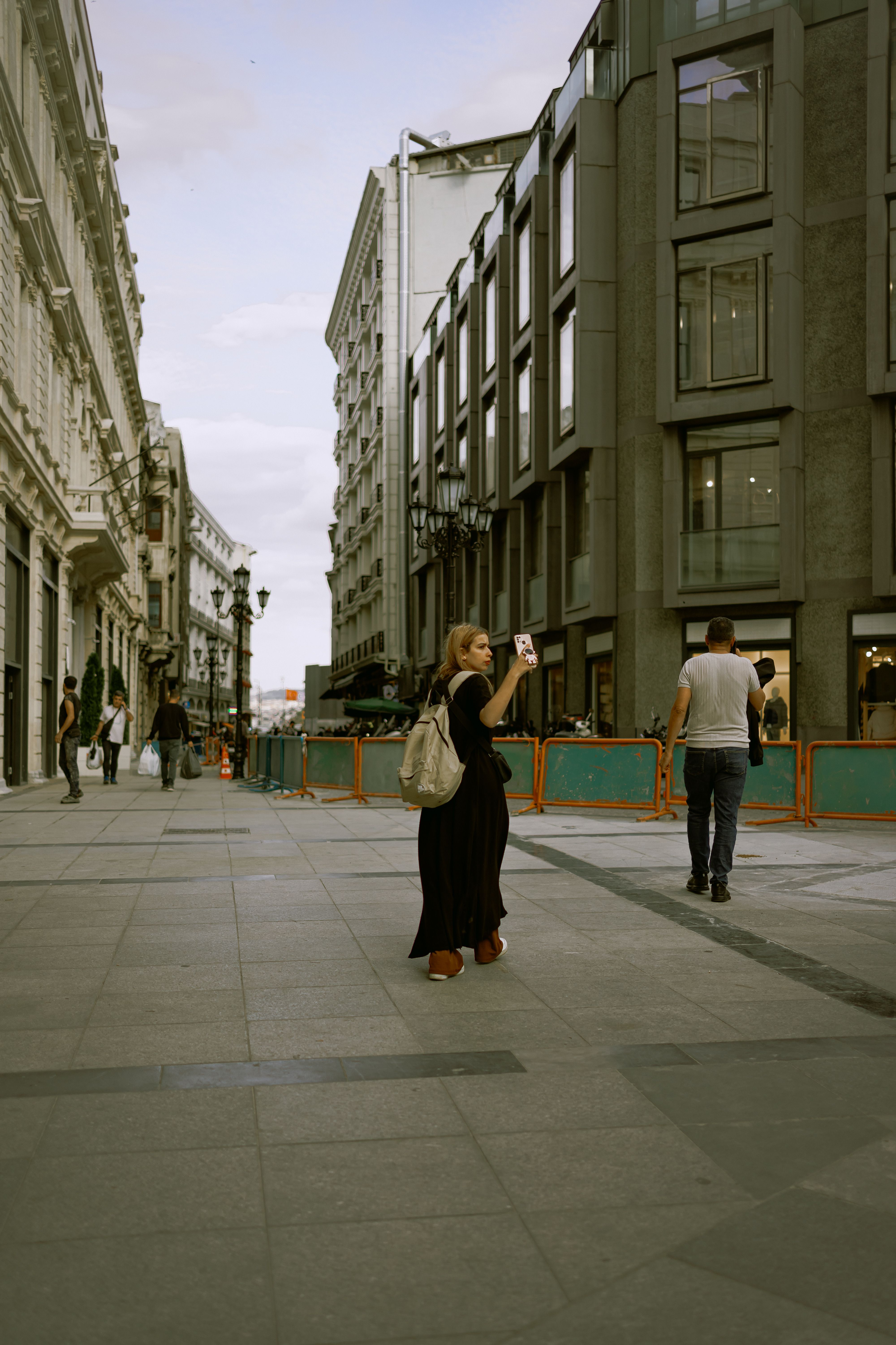 Pedestrians on a Street between Buildings · Free Stock Photo