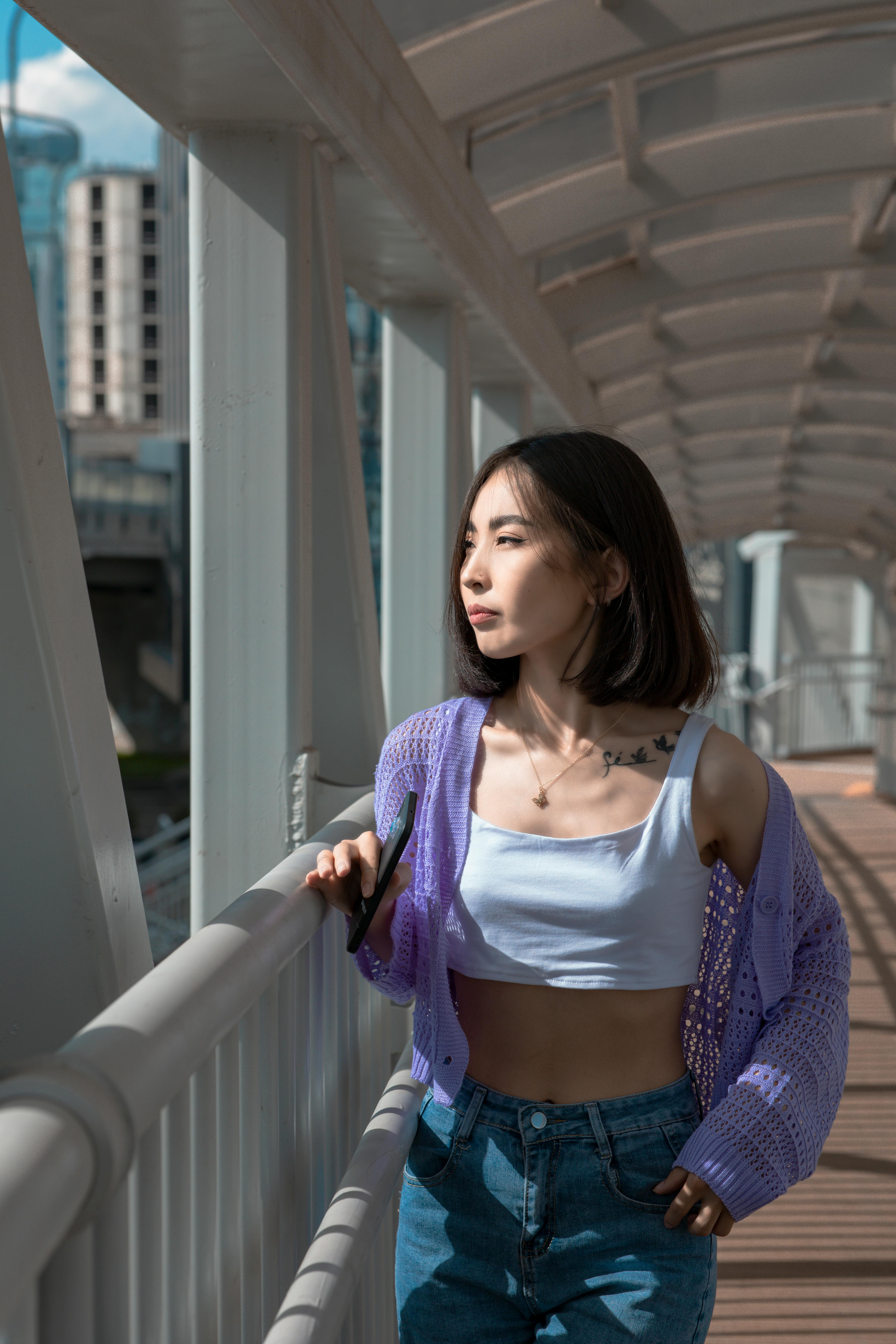 Girl Posing against a Concrete Structure · Free Stock Photo