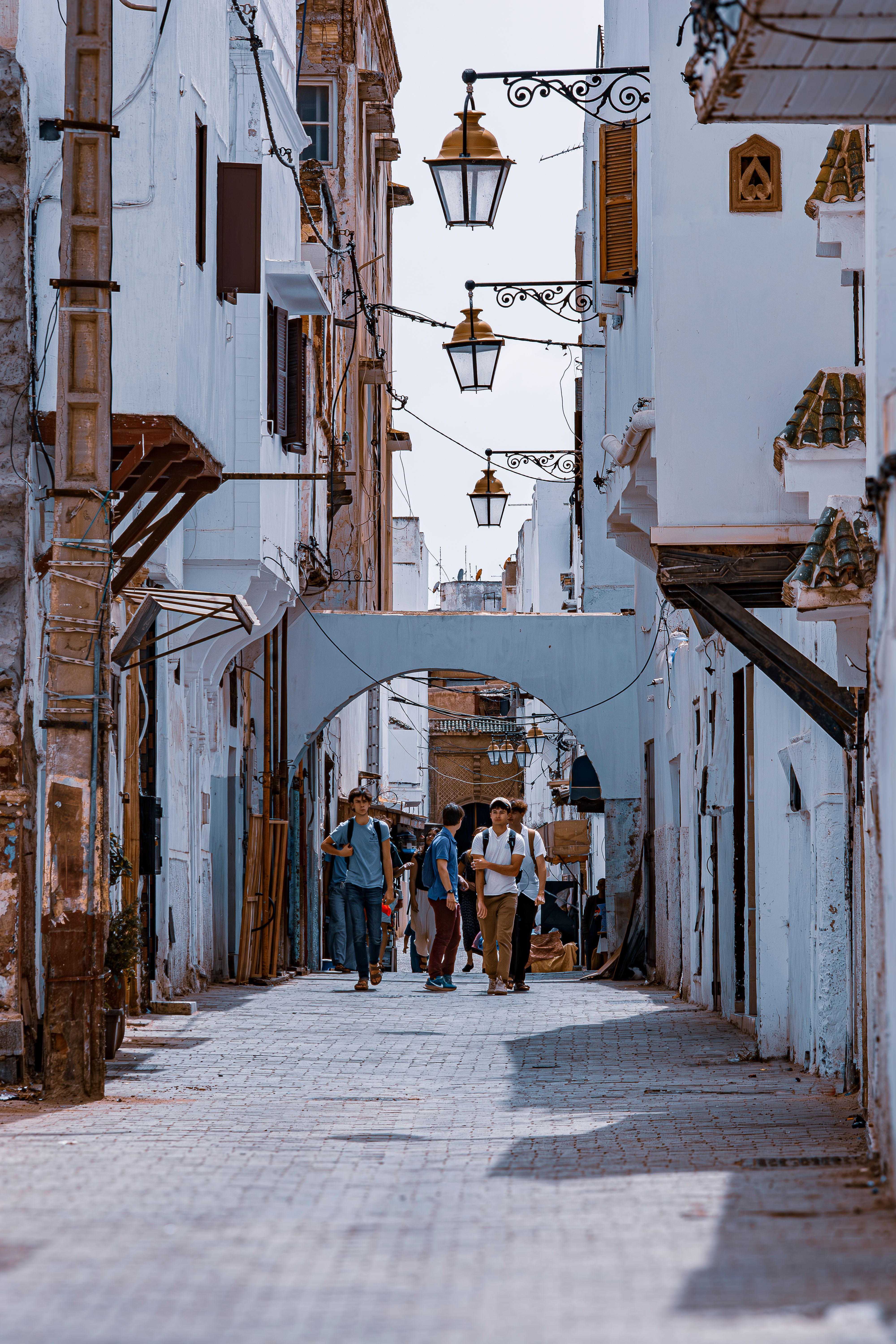 People in Alley with White Buildings · Free Stock Photo