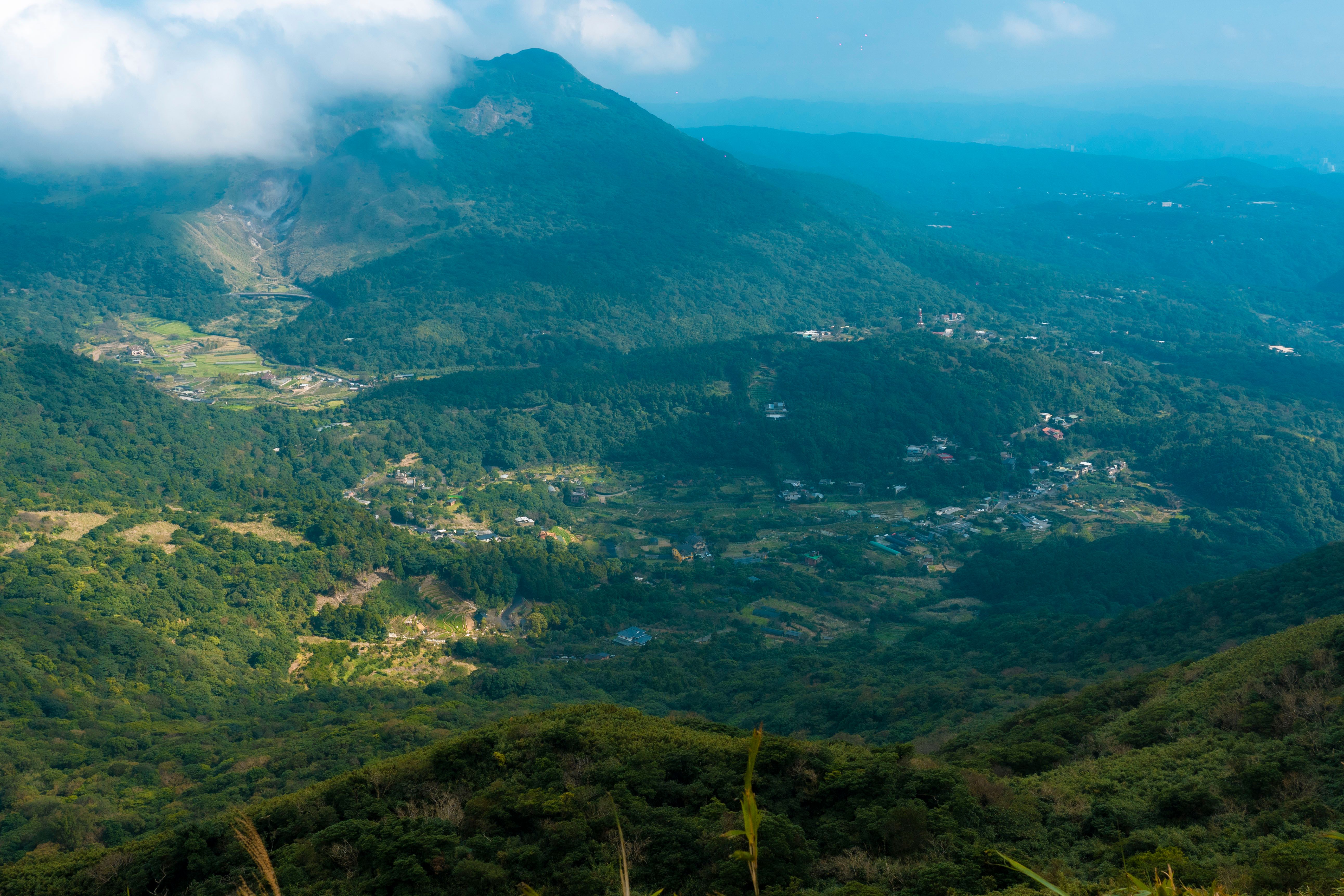 Town in a Valley Among Green Mountains · Free Stock Photo