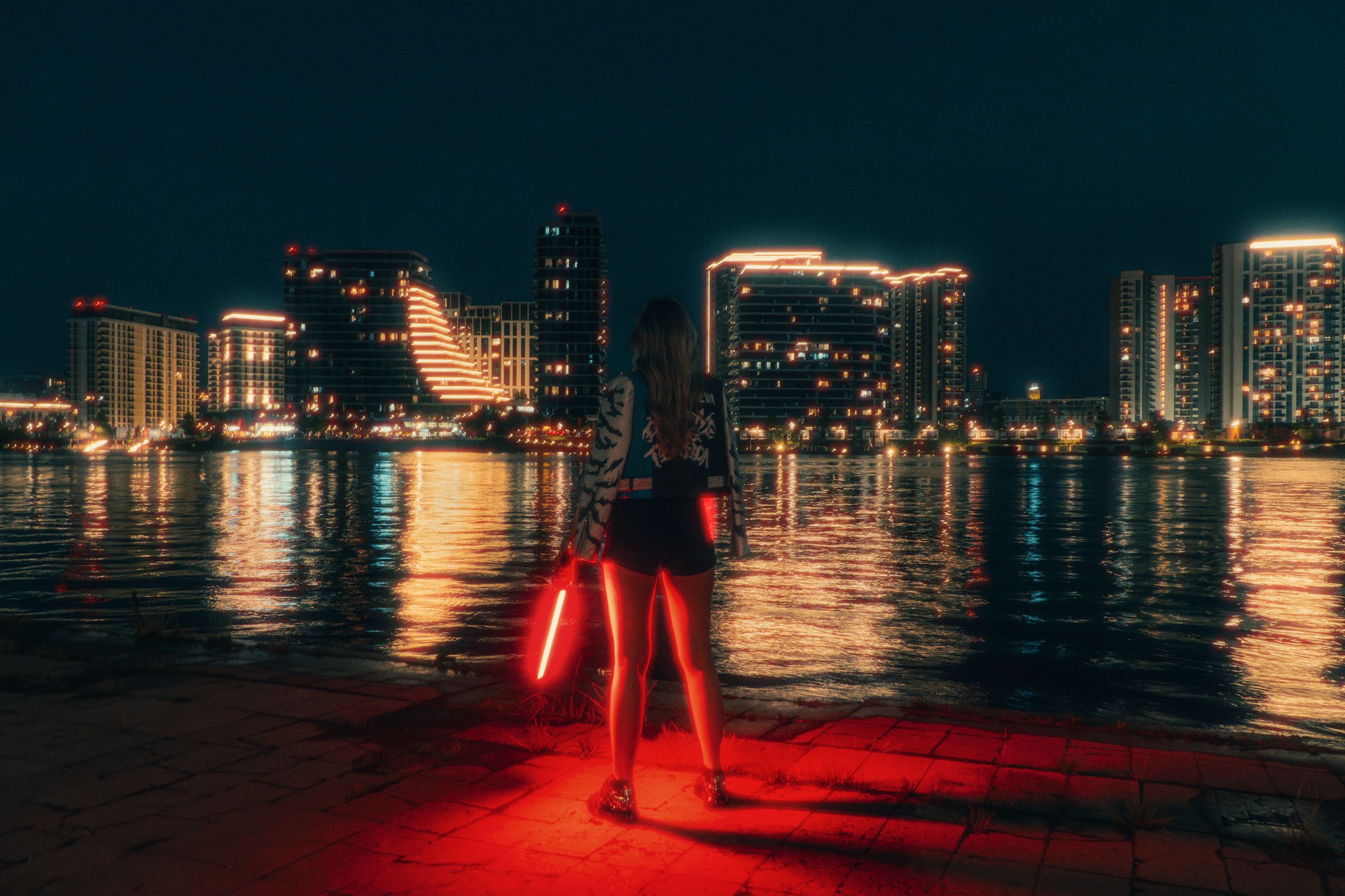 Woman with Red Light Standing by River at Night · Free Stock Photo