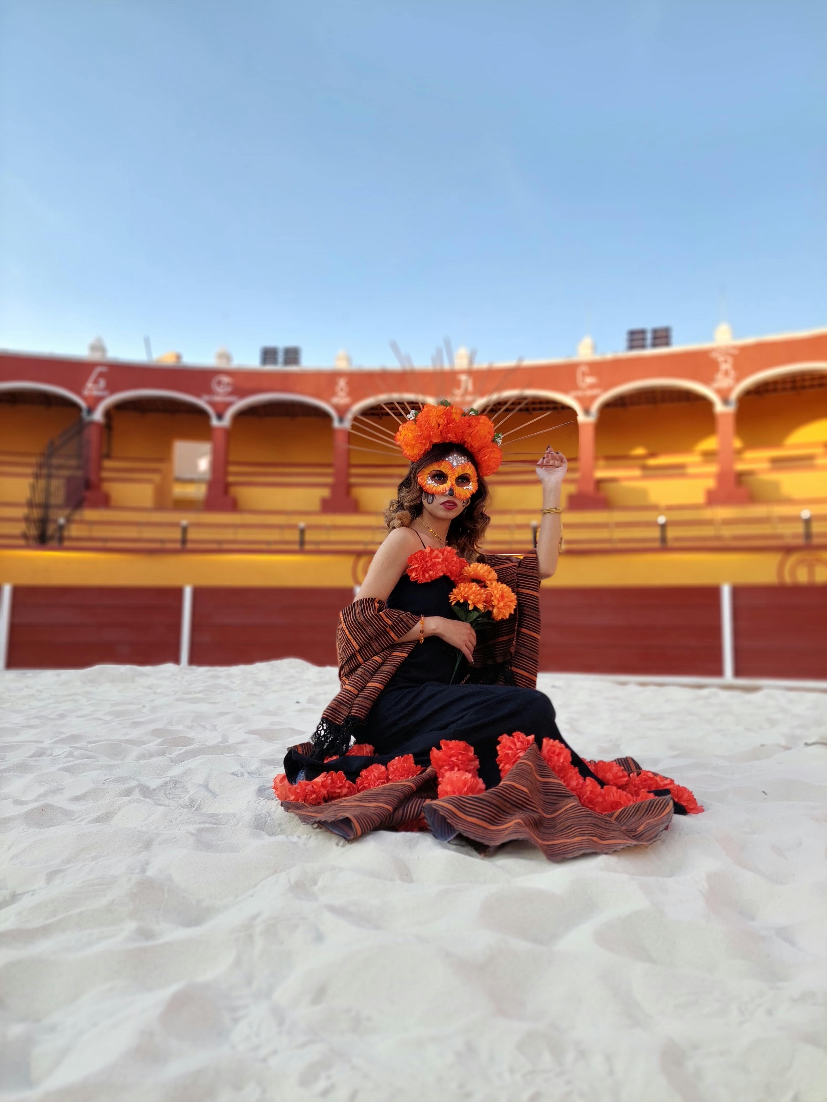 Woman in a Costume Sitting on the Sand in the Arena · Free Stock Photo
