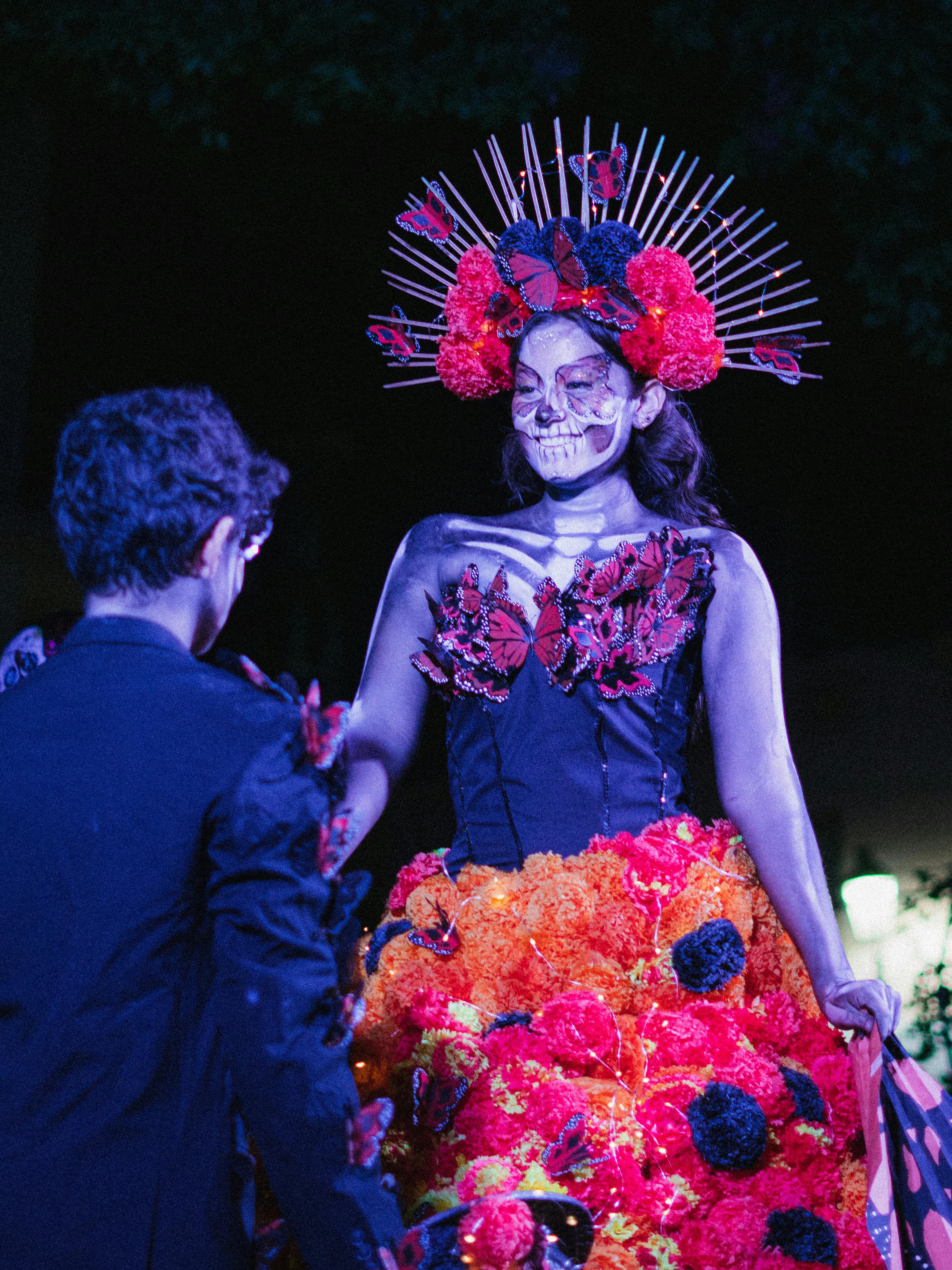 A Man Standing in Front of a Woman Dressed as a Catrina · Free Stock Photo