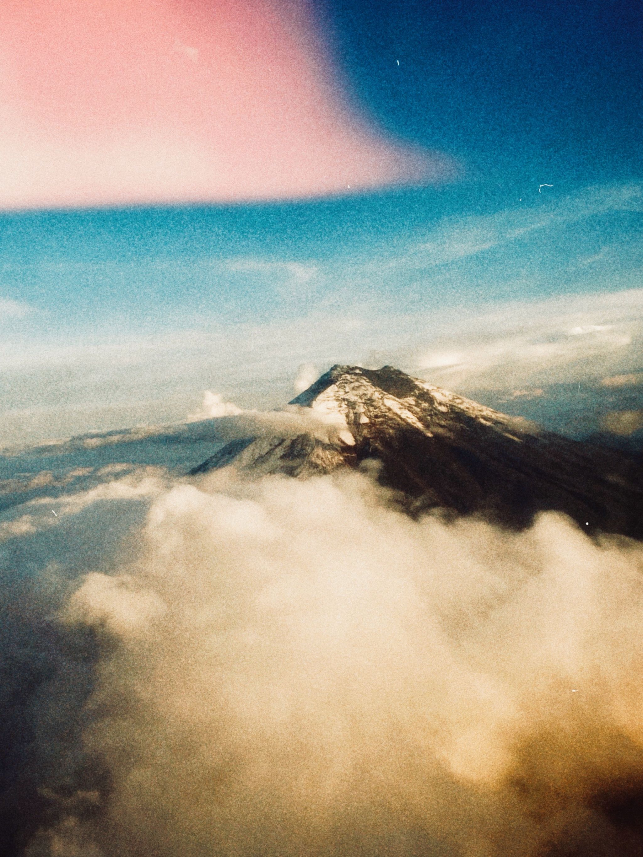 Aerial View of a Snow Covered Volcano Peak Among Clouds · Free Stock Photo