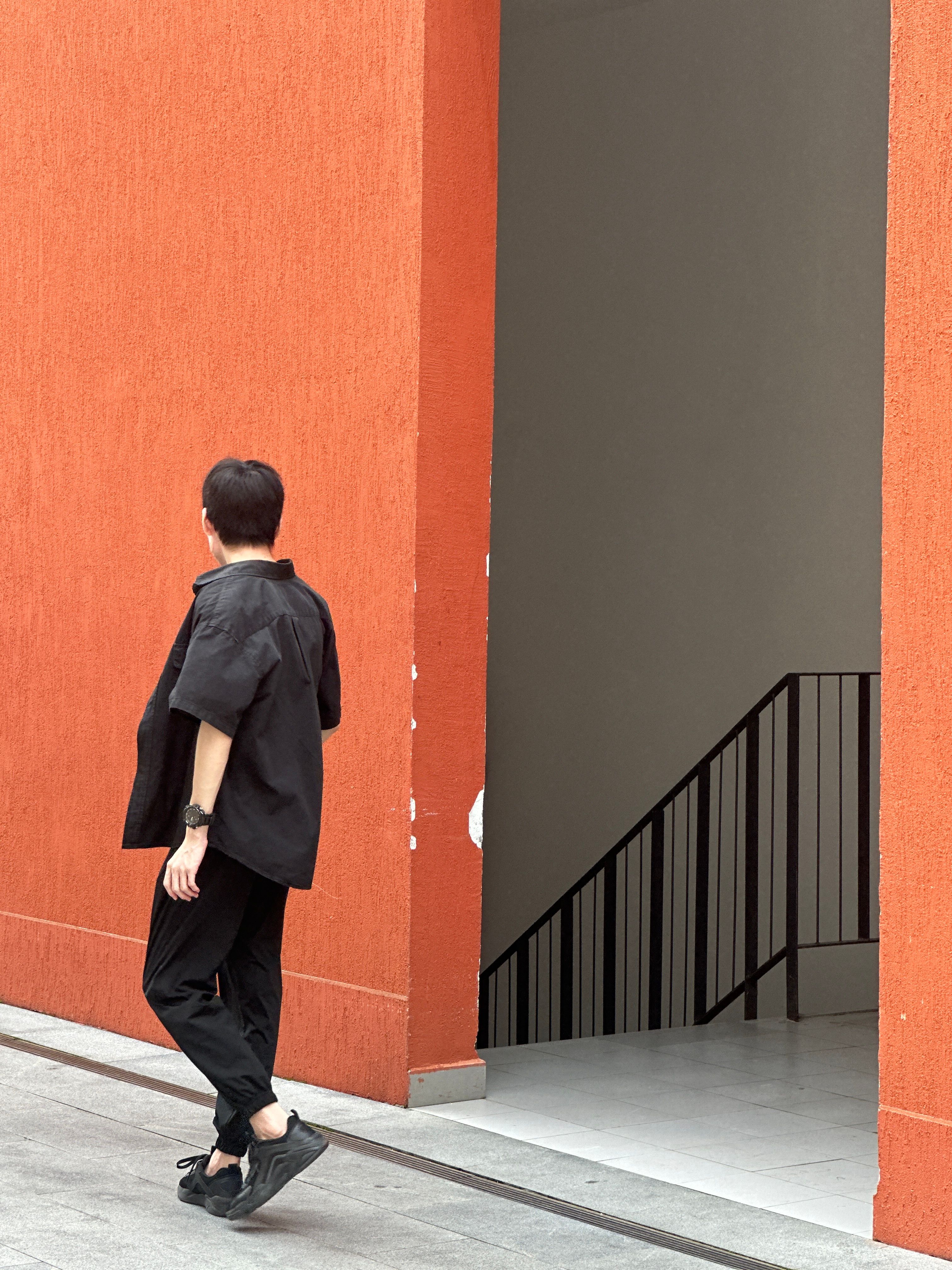 Man Walking near Building with Stairs · Free Stock Photo