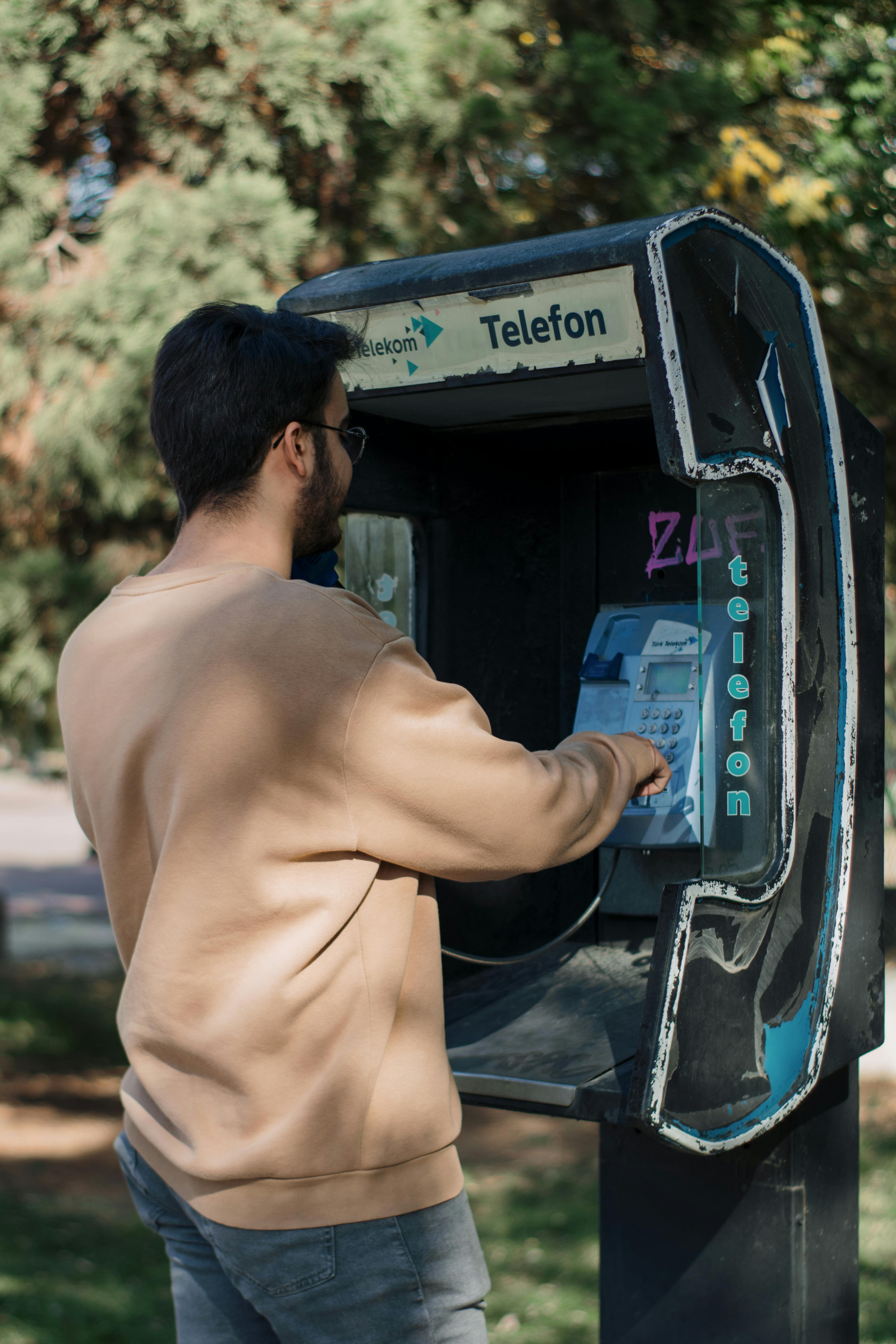 Man Using a Payphone · Free Stock Photo