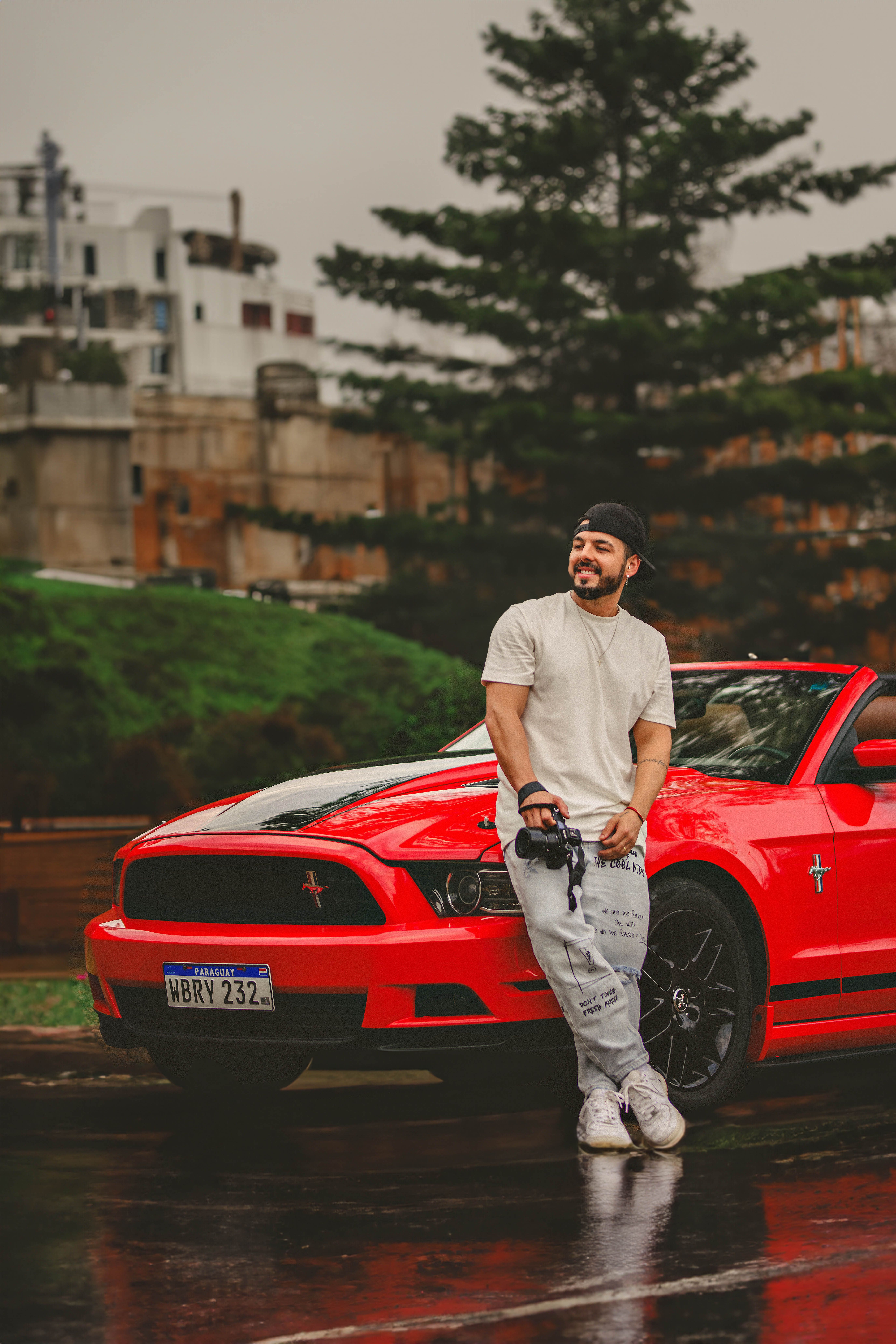 Man Standing in Front of Red Mustang · Free Stock Photo