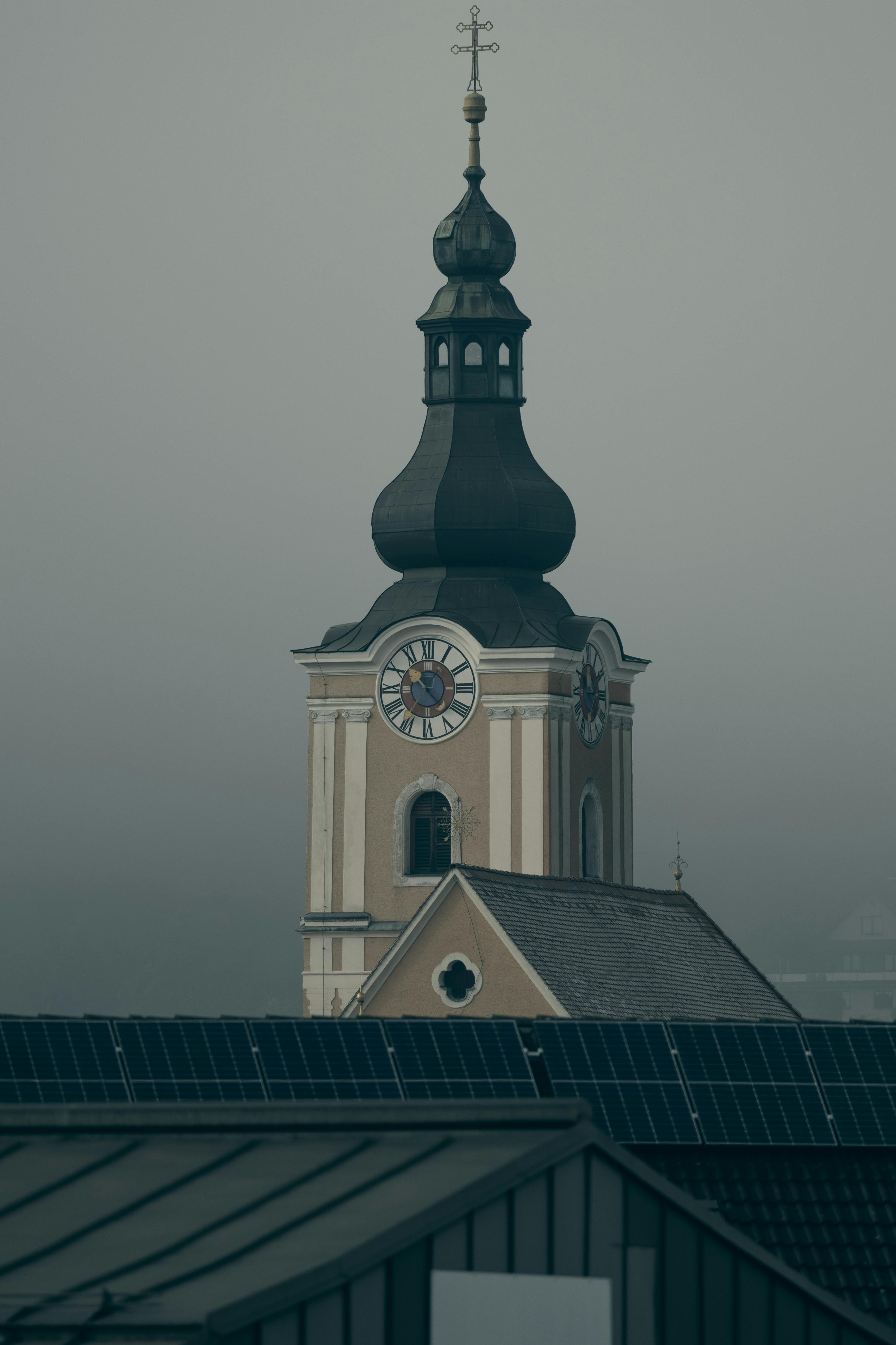 Church Tower over Buildings Roofs · Free Stock Photo