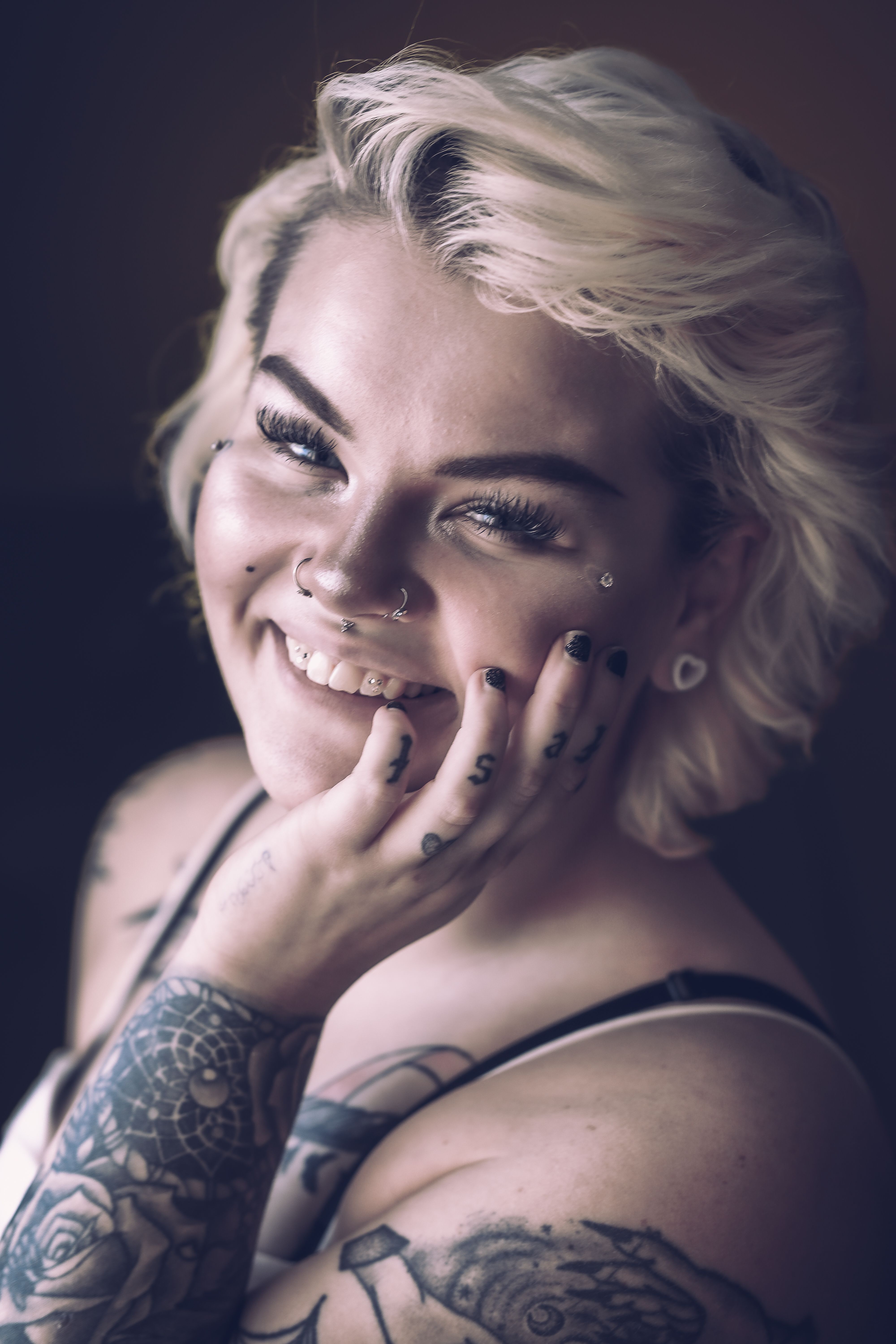 Smiling Blonde Woman with Hand on Cheek · Free Stock Photo