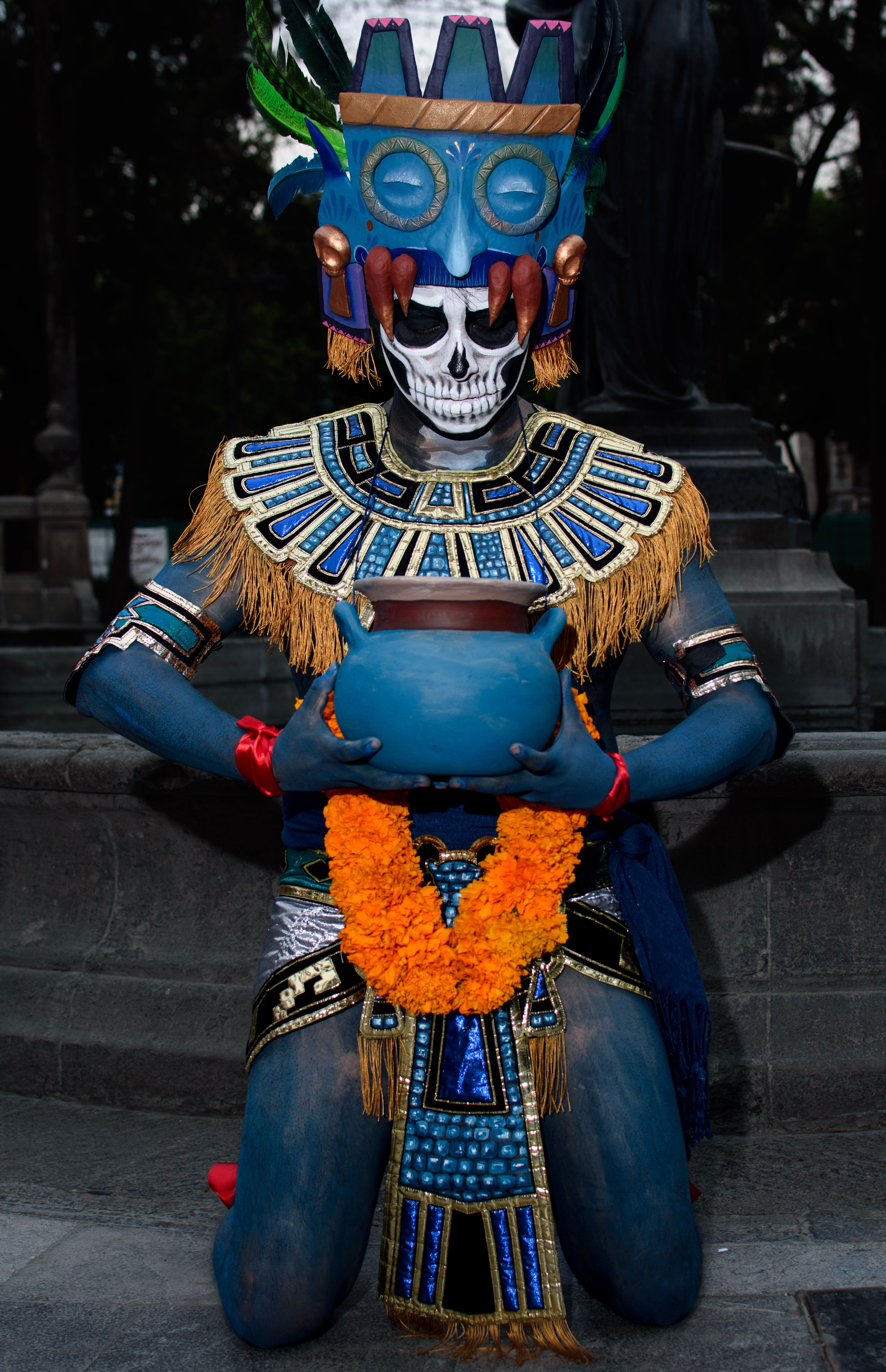 Man in Traditional Costume Holding Jar near Stone Monument · Free Stock ...