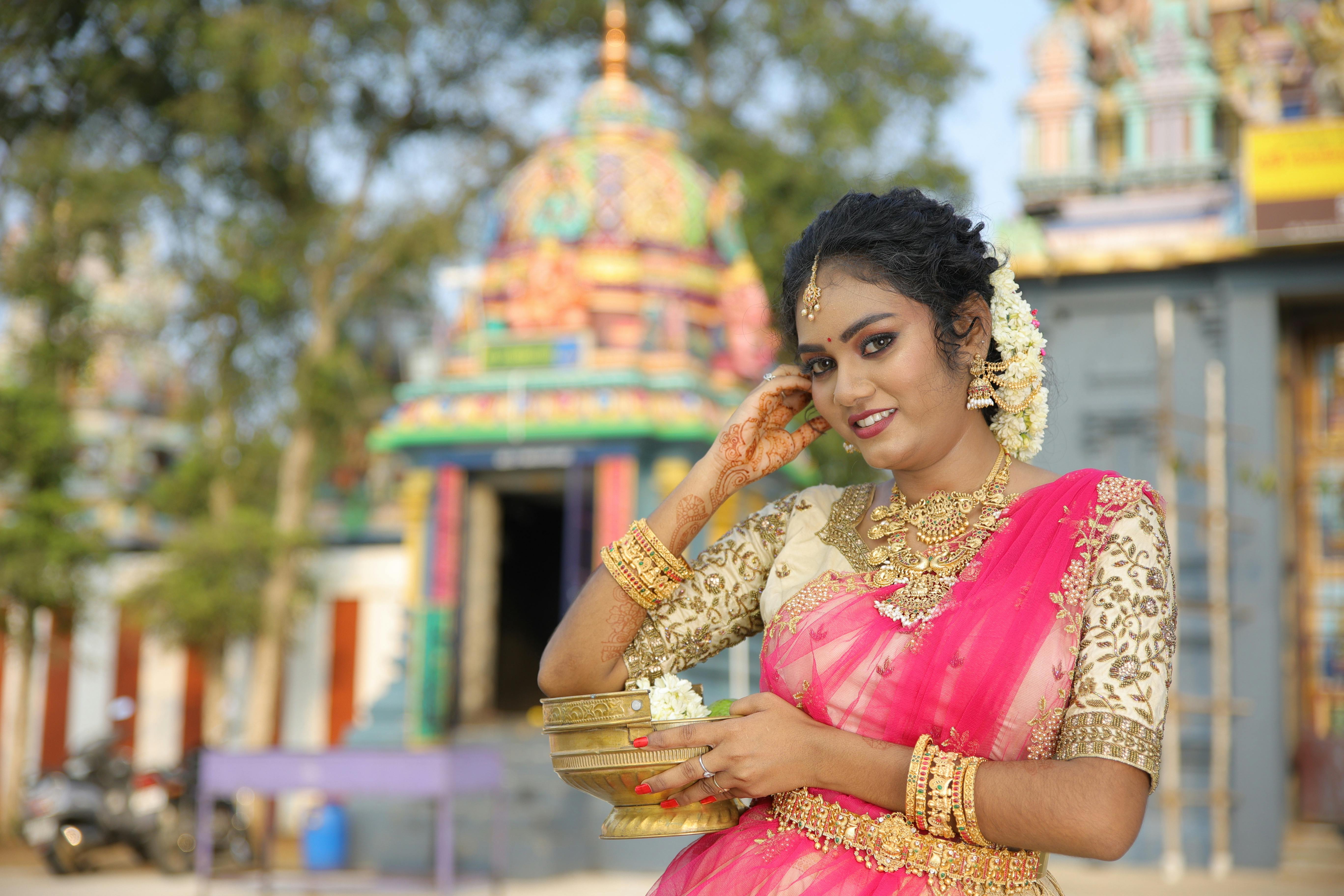 Hindu Woman in White Dress Leaning against Ladder · Free Stock Photo