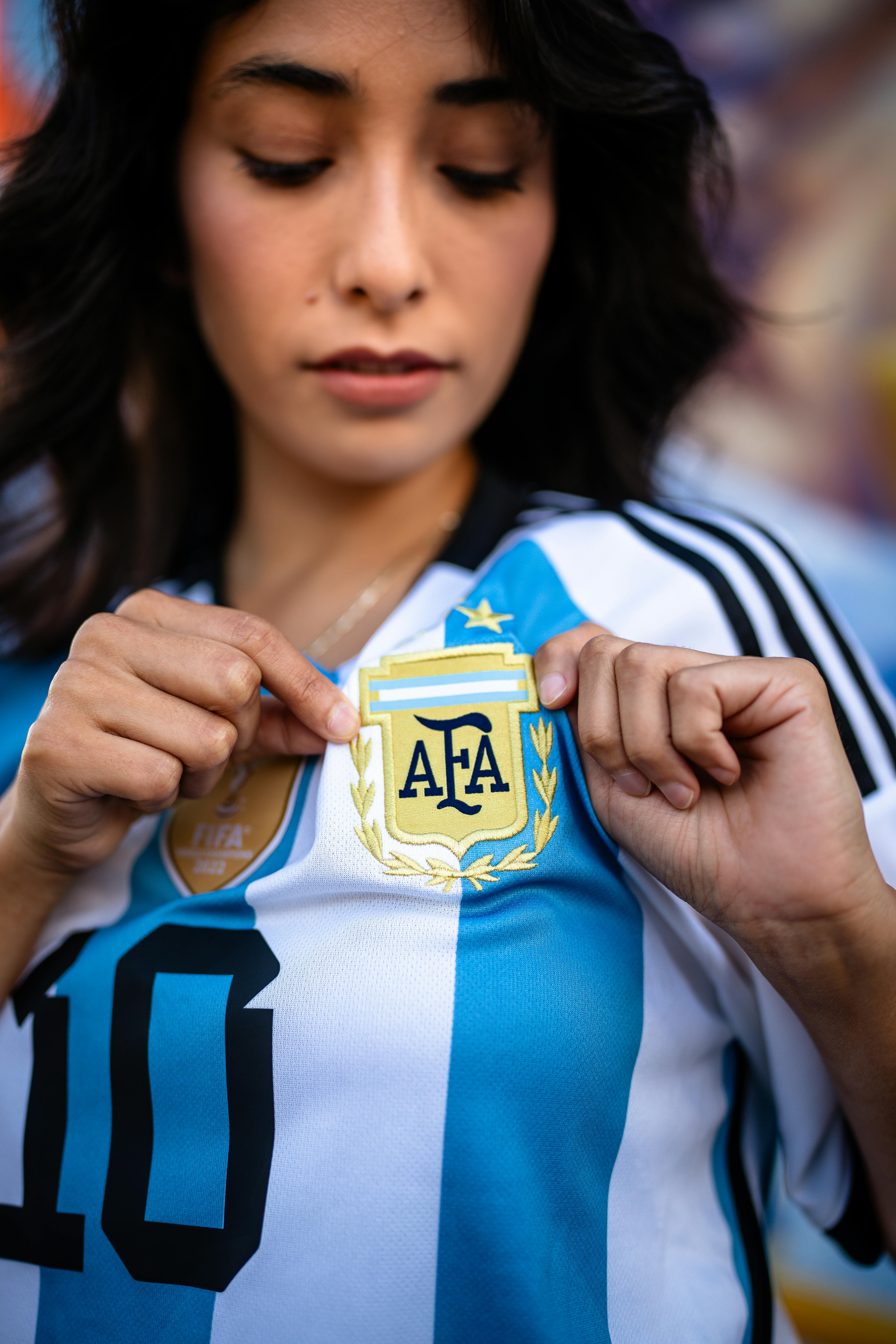 Brunette Woman in Argentinian Football Shirt Holding Hands in Pockets ...