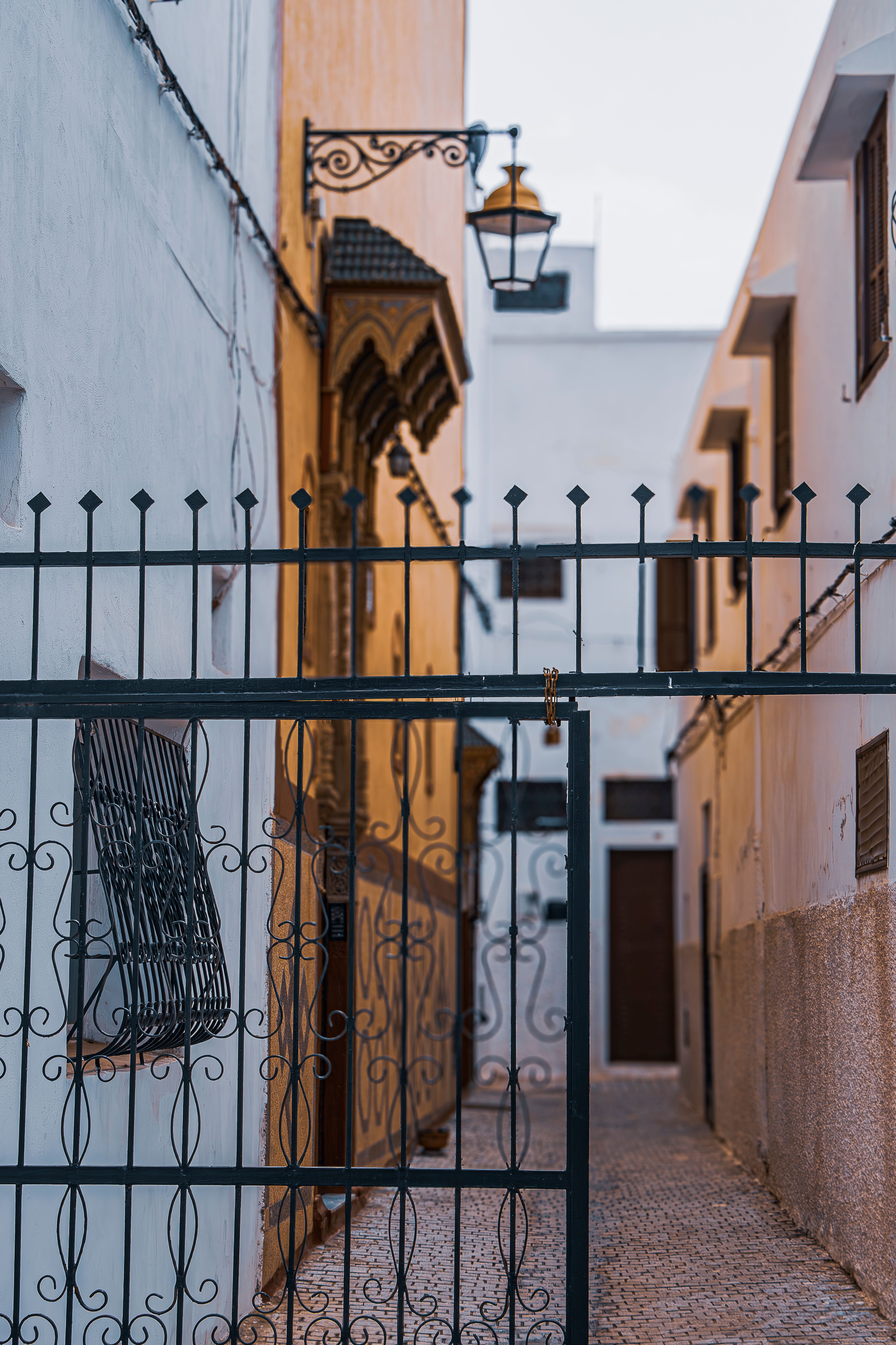 Fence in a Narrow Alley · Free Stock Photo