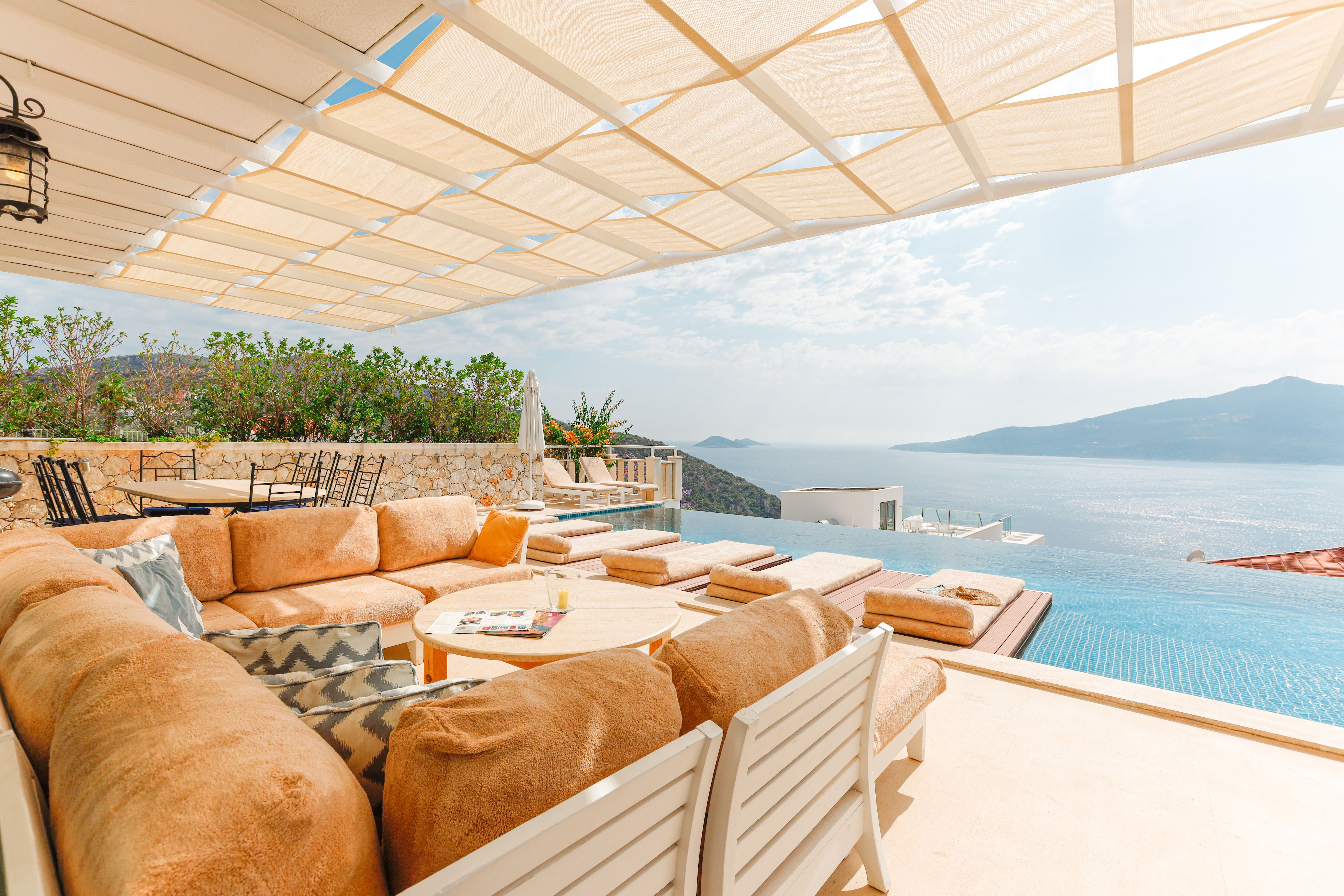 Table and Sofa on the Roofed Terrace with a View of Sea · Free Stock Photo