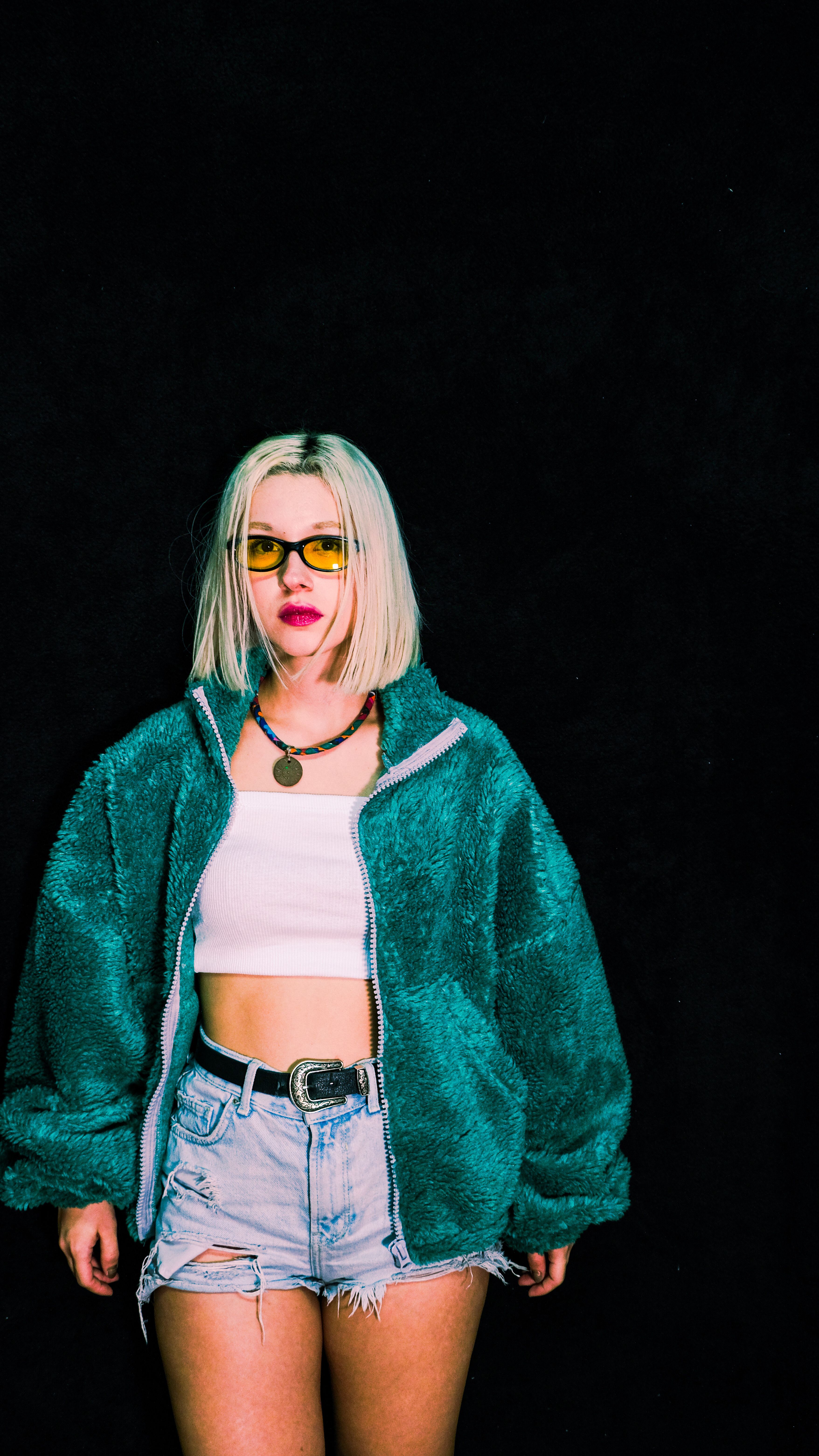 Woman in Denim Short and Green Fluffy Jacket · Free Stock Photo