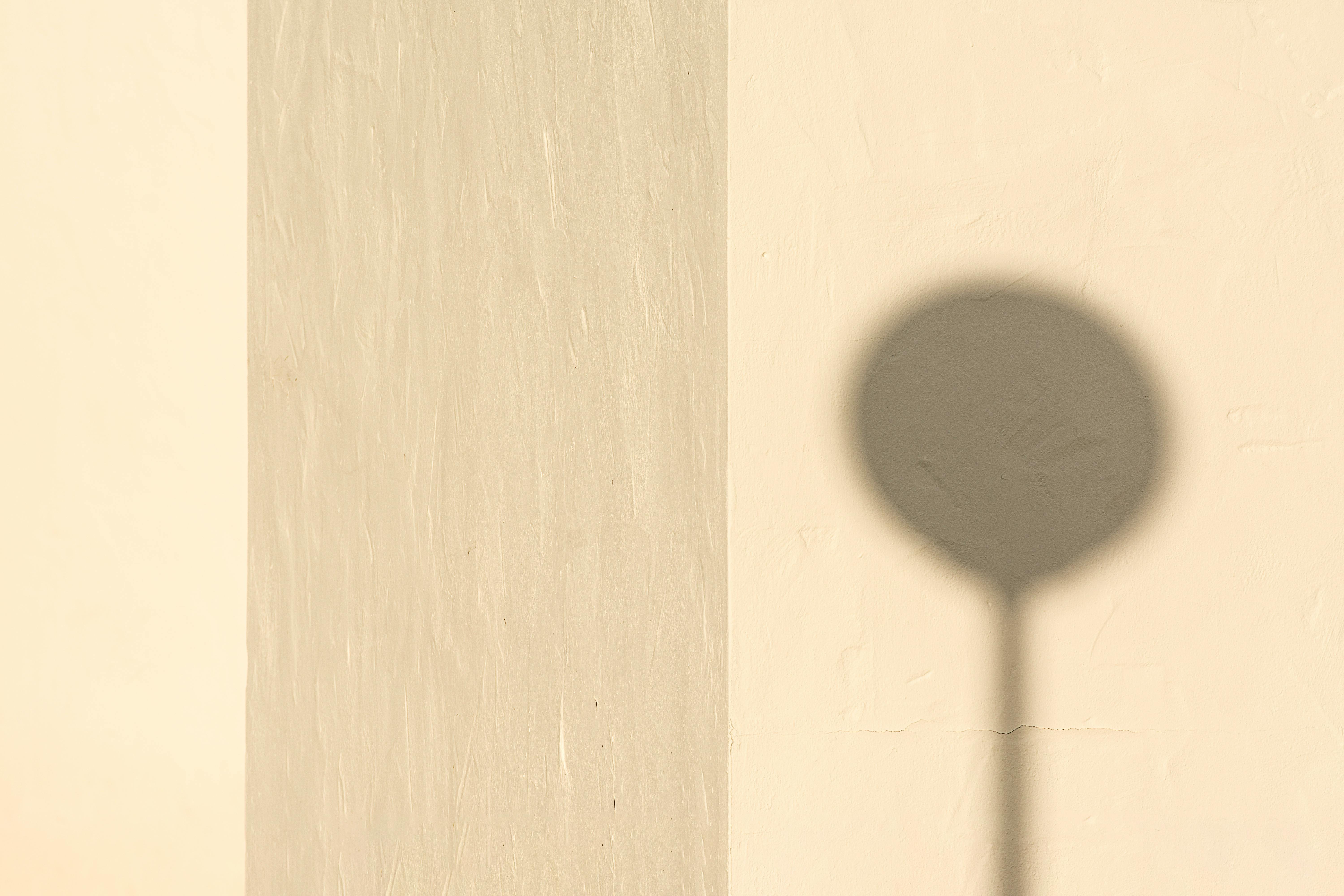 Circular Shadow on a Light Wall · Free Stock Photo