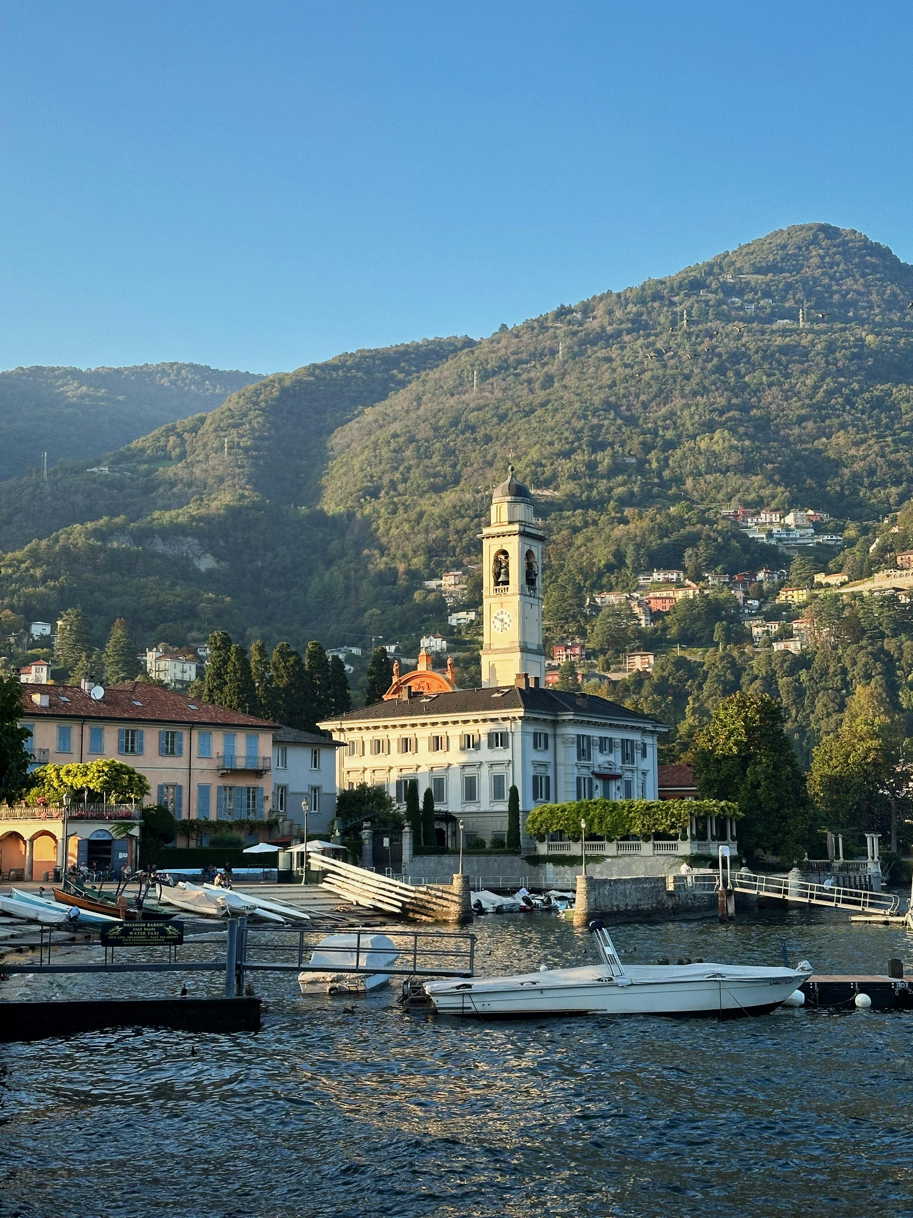 Motorboat Sailing on Lake Como Surrounded by Alps · Free Stock Photo