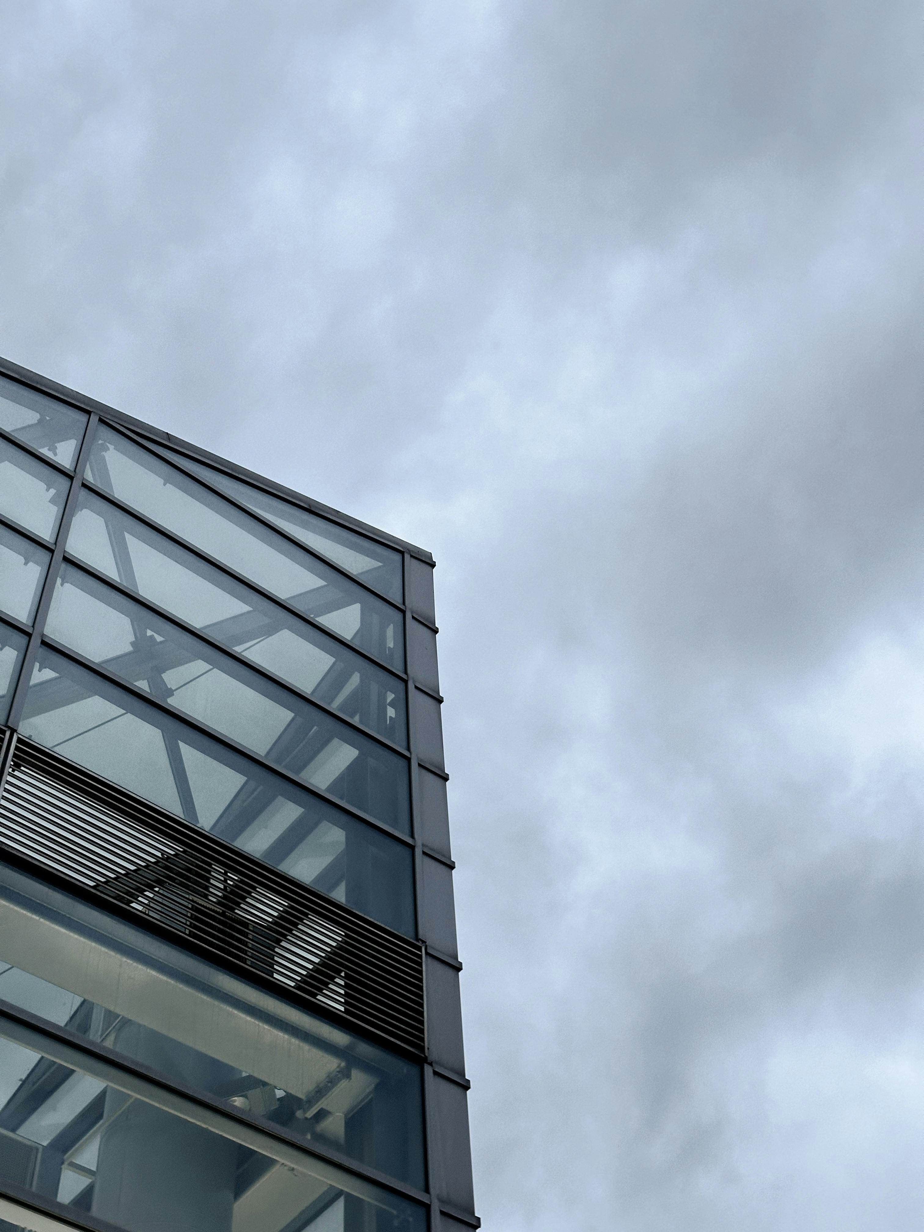 Cloudy Sky Above Glass Building · Free Stock Photo