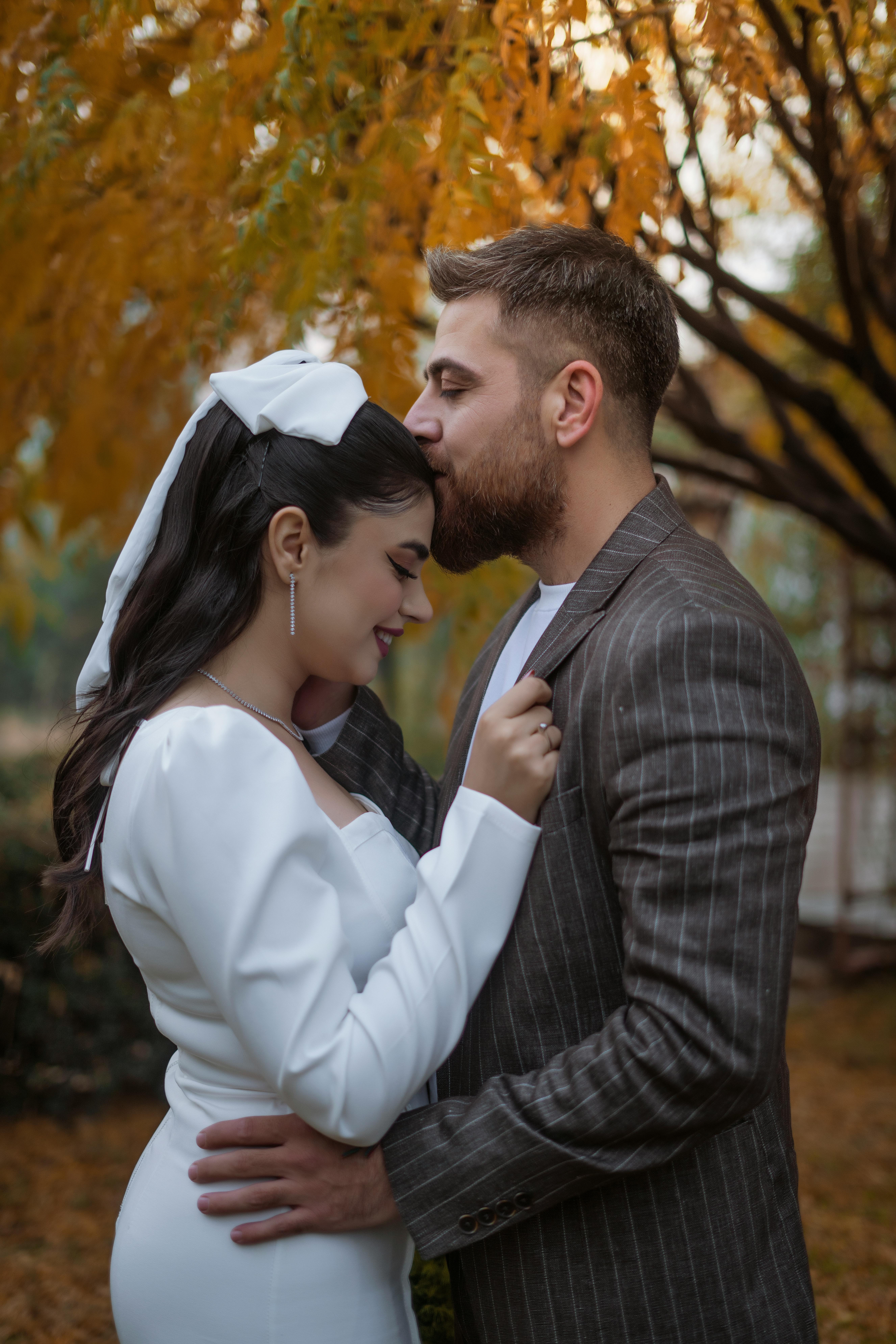 Groom Kissing the Bride on the Forehead · Free Stock Photo