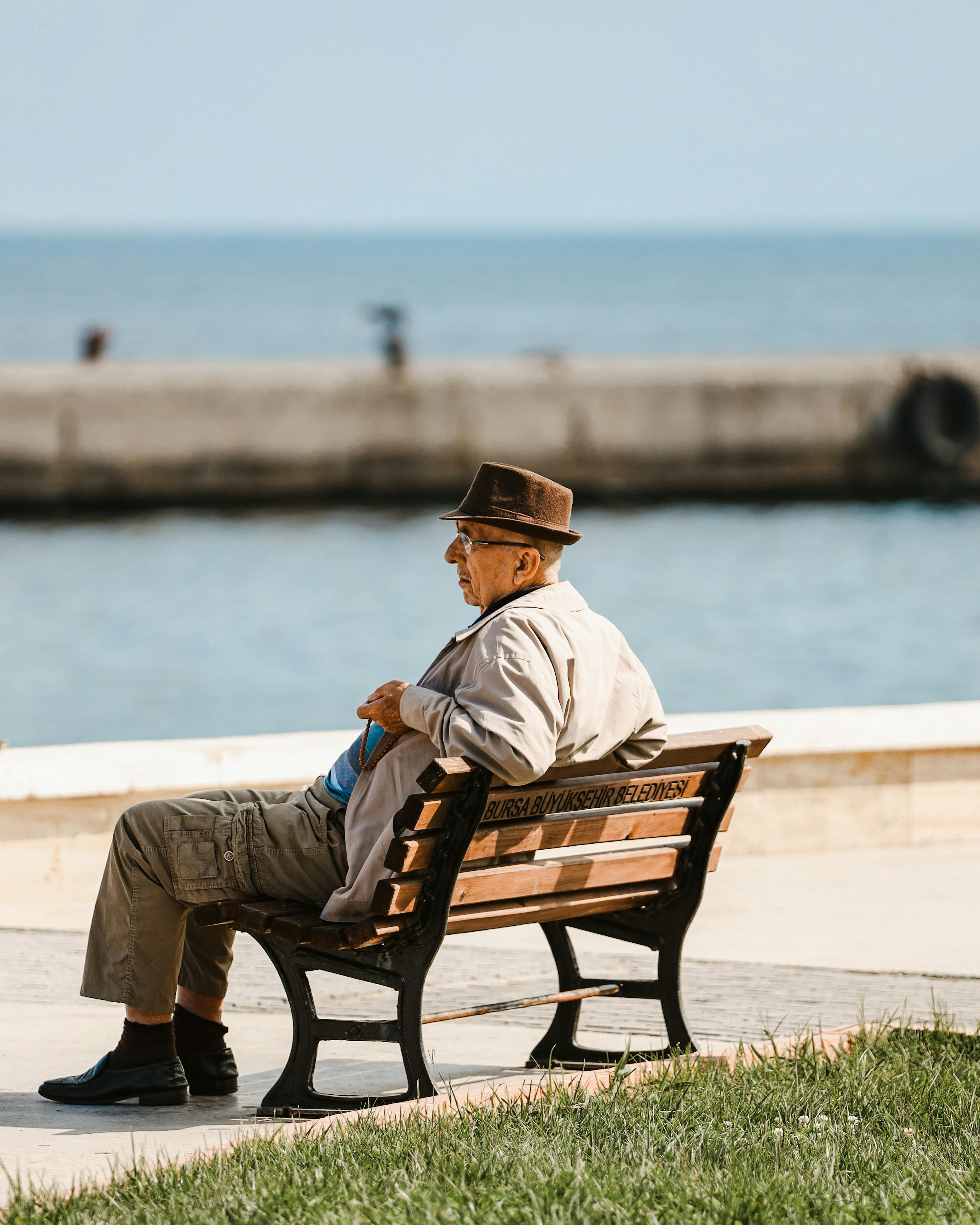 Man Sitting On Park Bench · Free Stock Photo