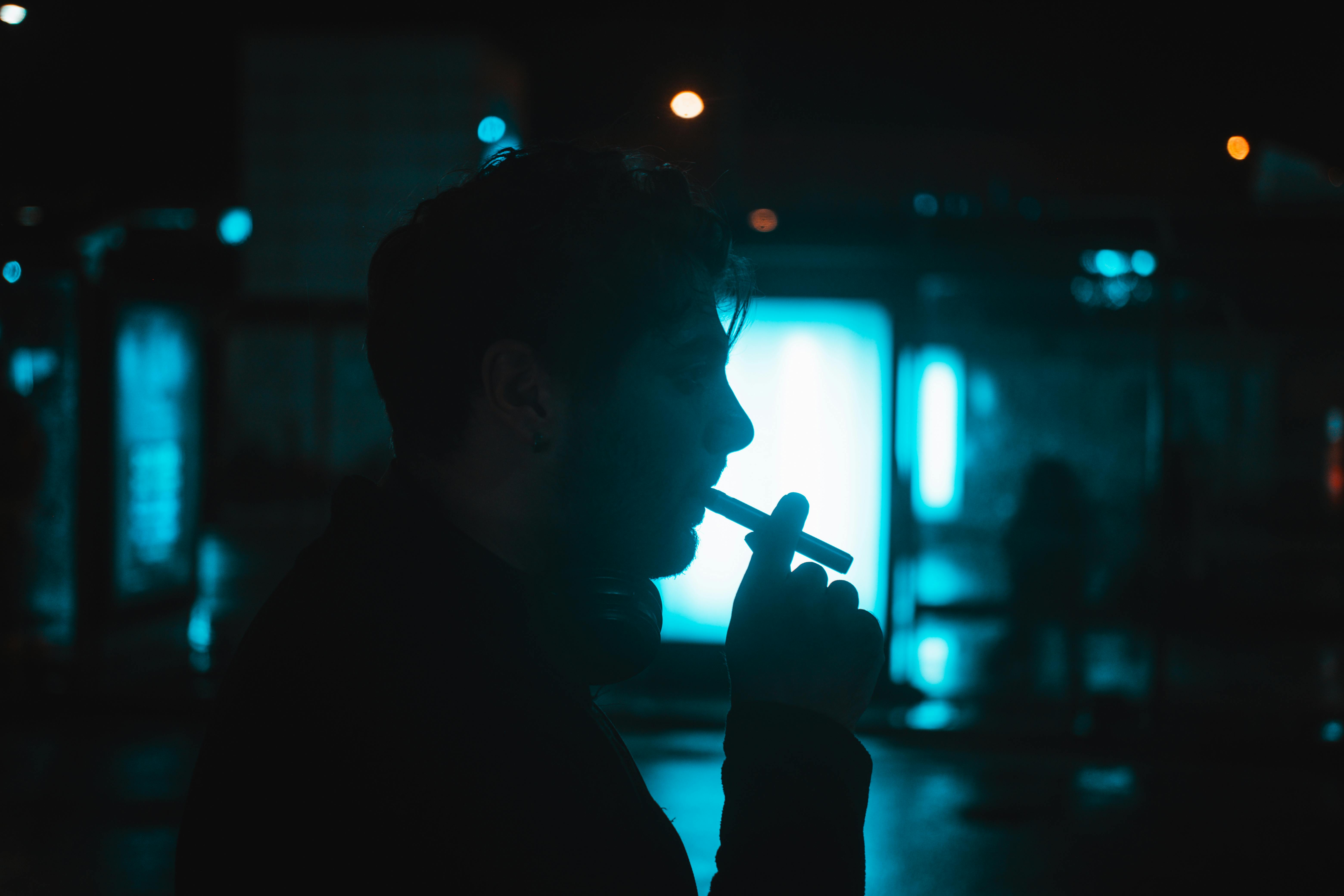 Man Smoking a Cigarette in a City Street at Night · Free Stock Photo