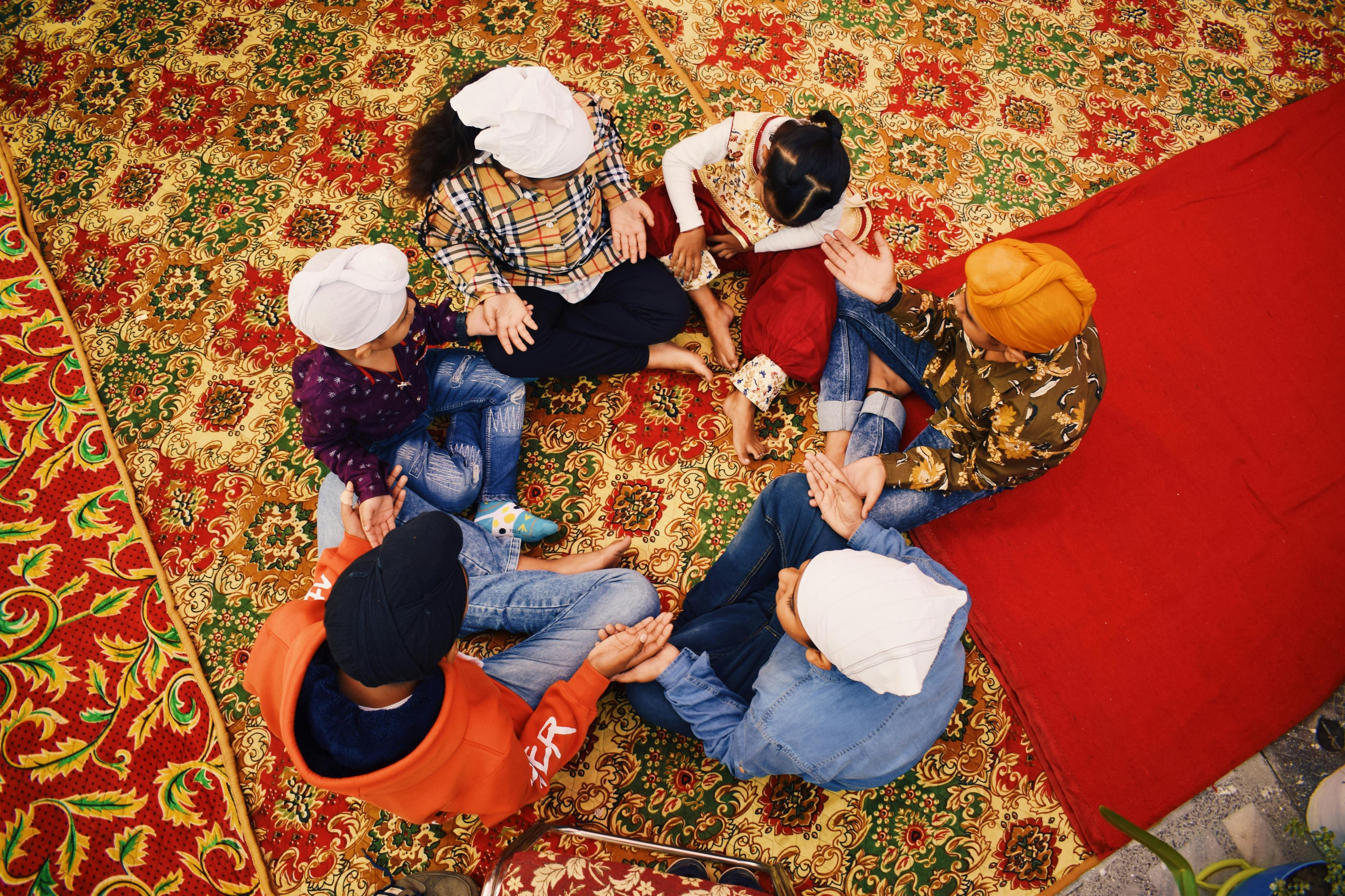 Group of Children Sitting in a Huddle on the Carpet · Free Stock Photo